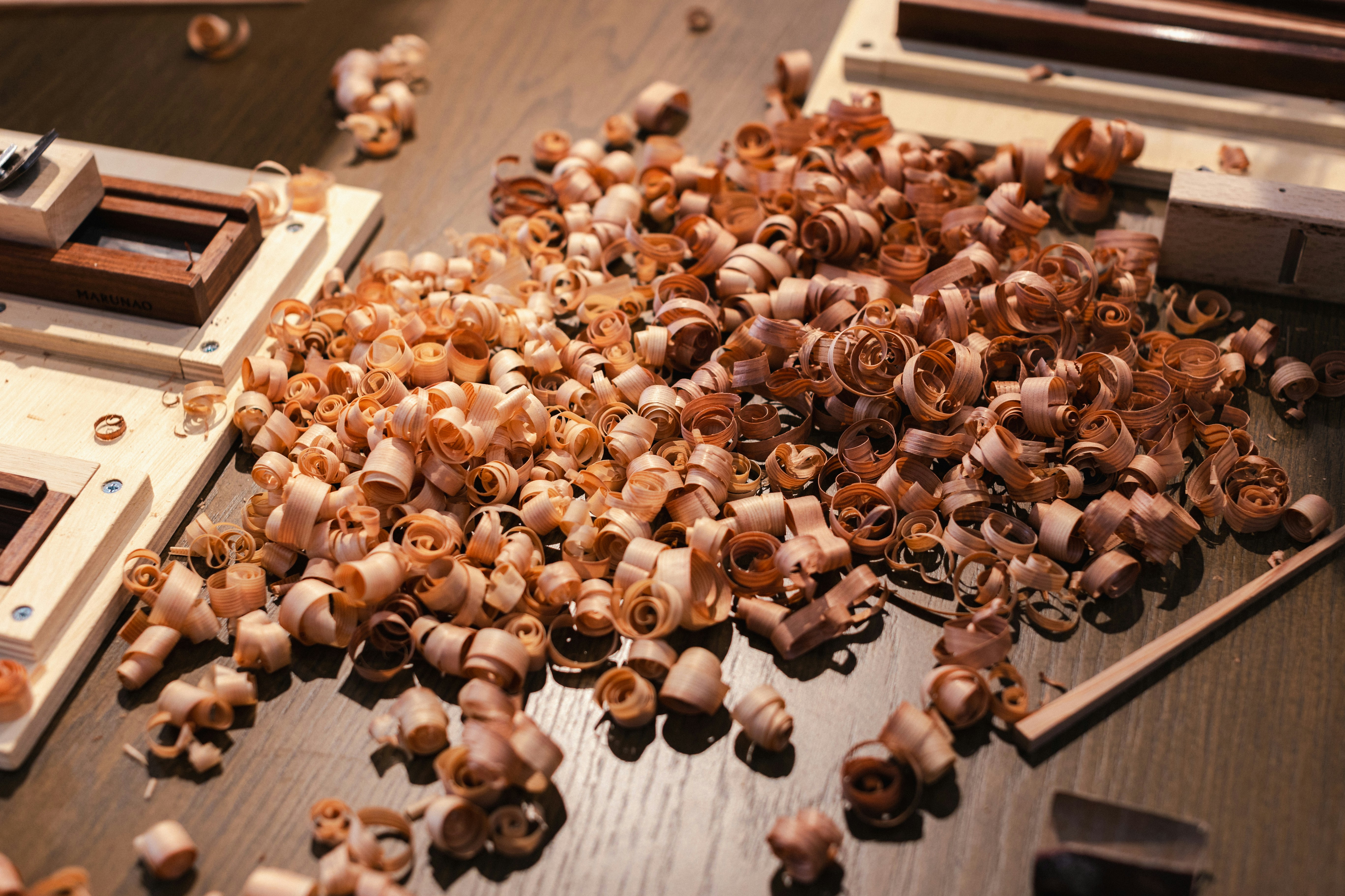 Whorls on the Bench: copper-toned shavings weave a quiet tapestry