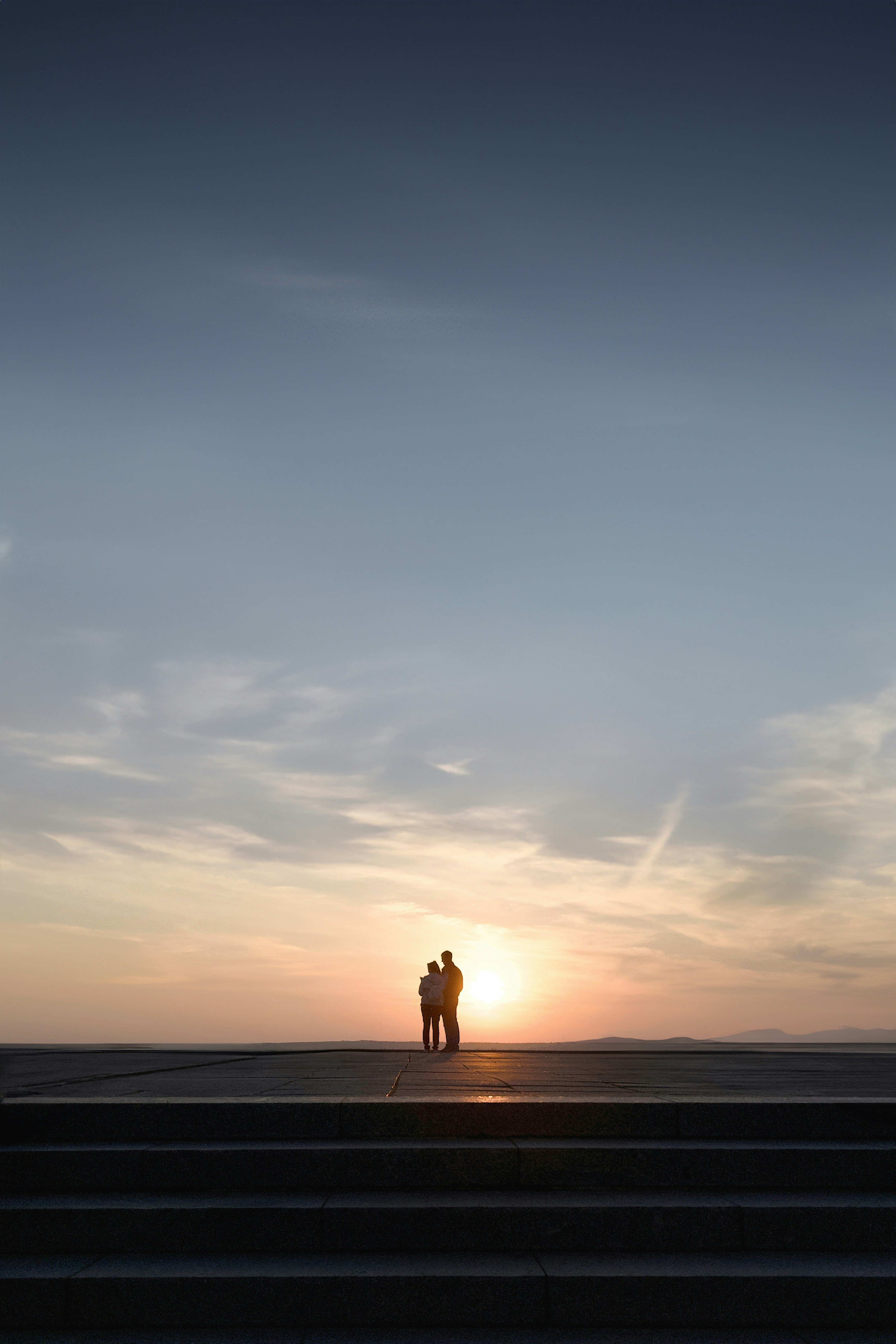 Two people standing on a set of stairs at sunset photo – Free Outdoors ...