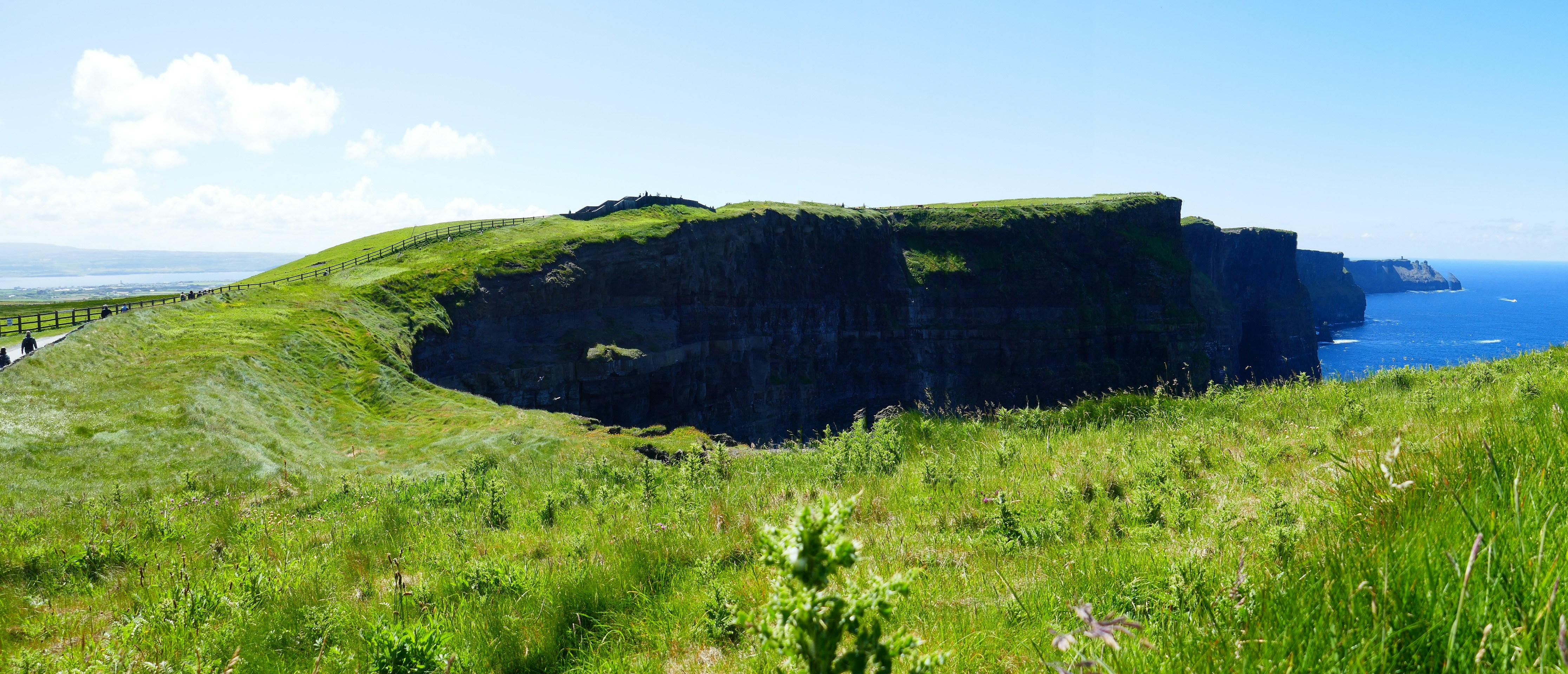 A grassy hill with a large hole in the middle of it photo – Free Cliffs ...
