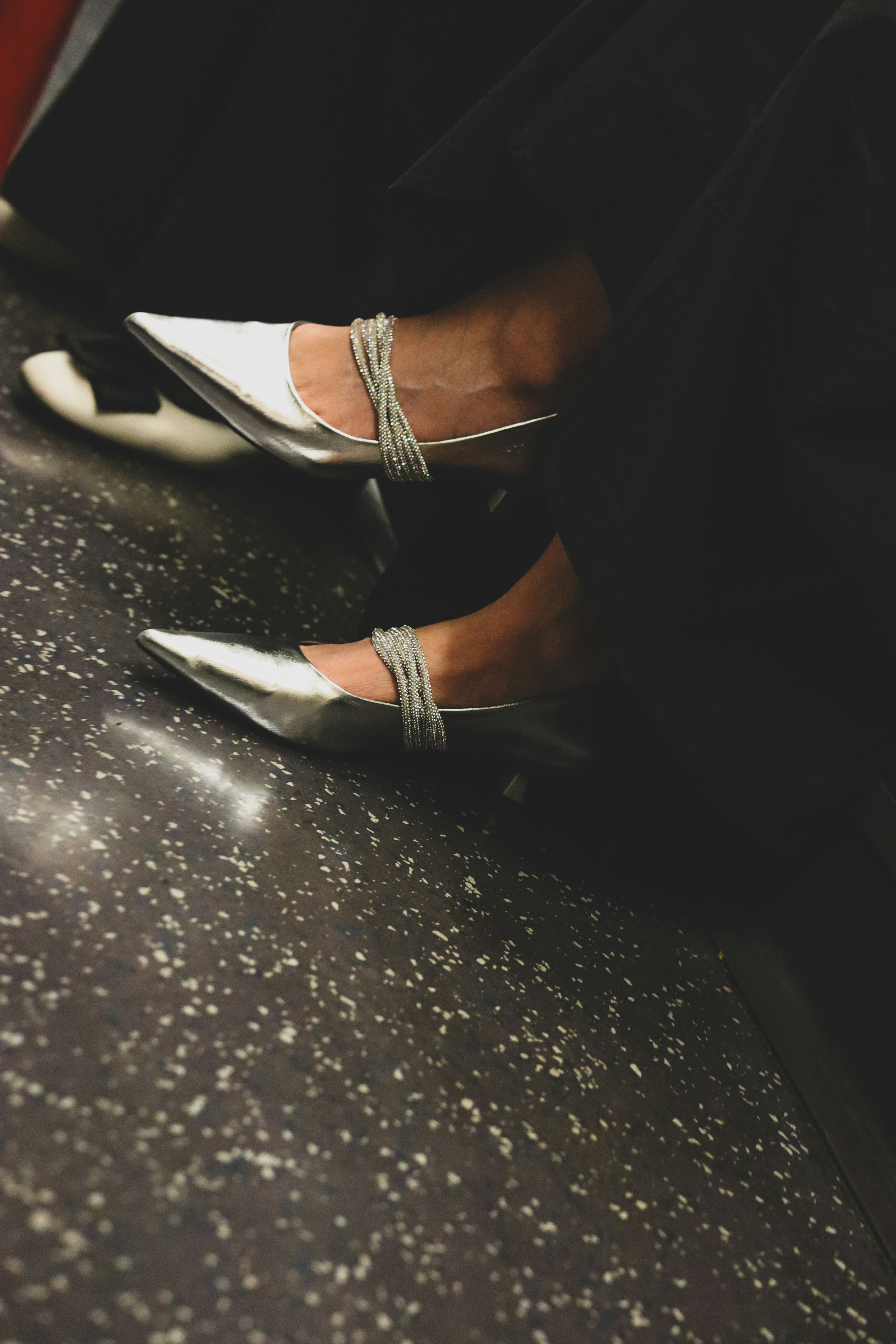 Shimmering Steps: Silver Heels Resting on a Glittering Stair