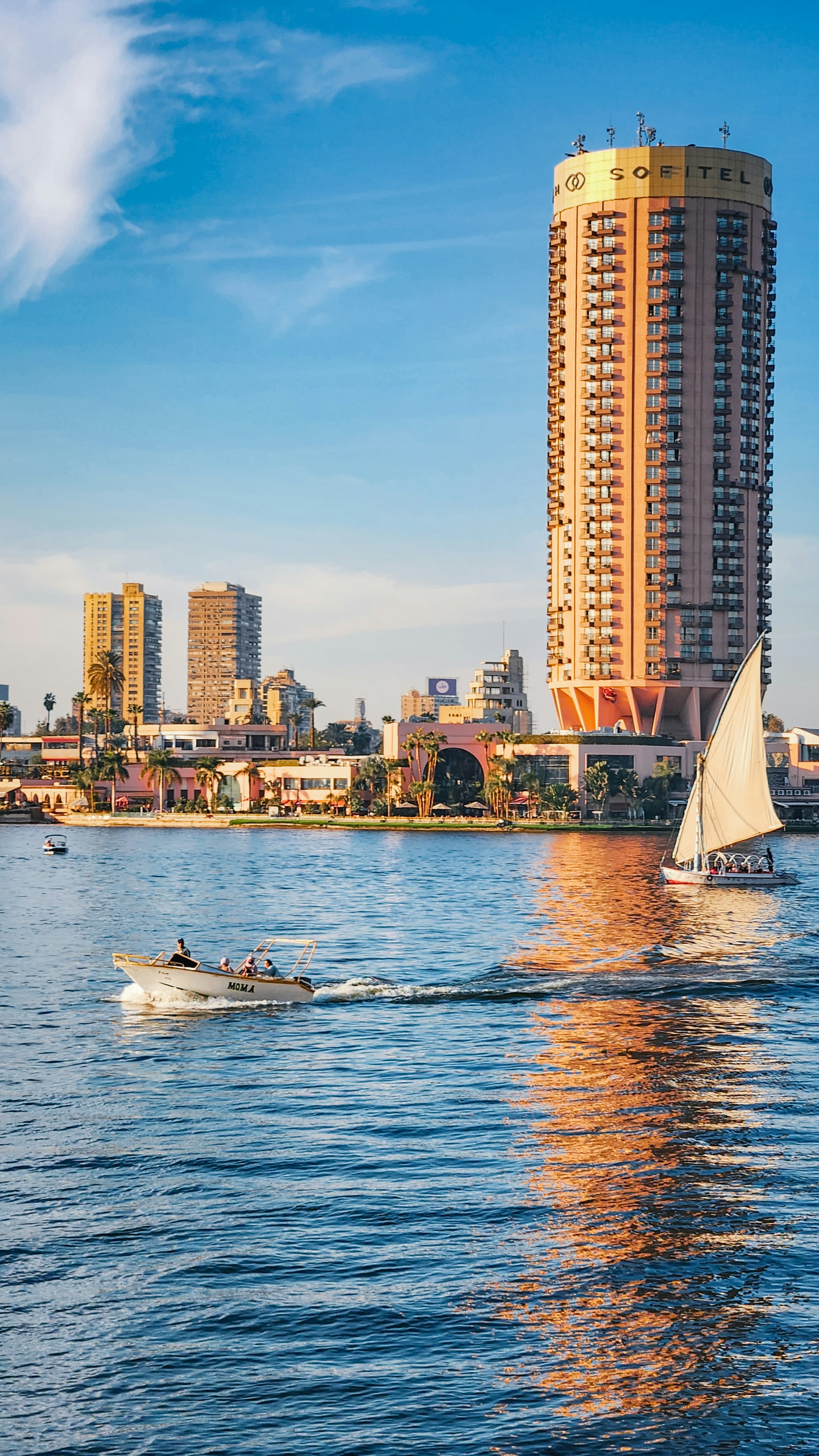 An elegant hotel in the heart of Cairo, perfectly positioned on the Nile, with stunning vistas of the serene river and clear blue skies.
