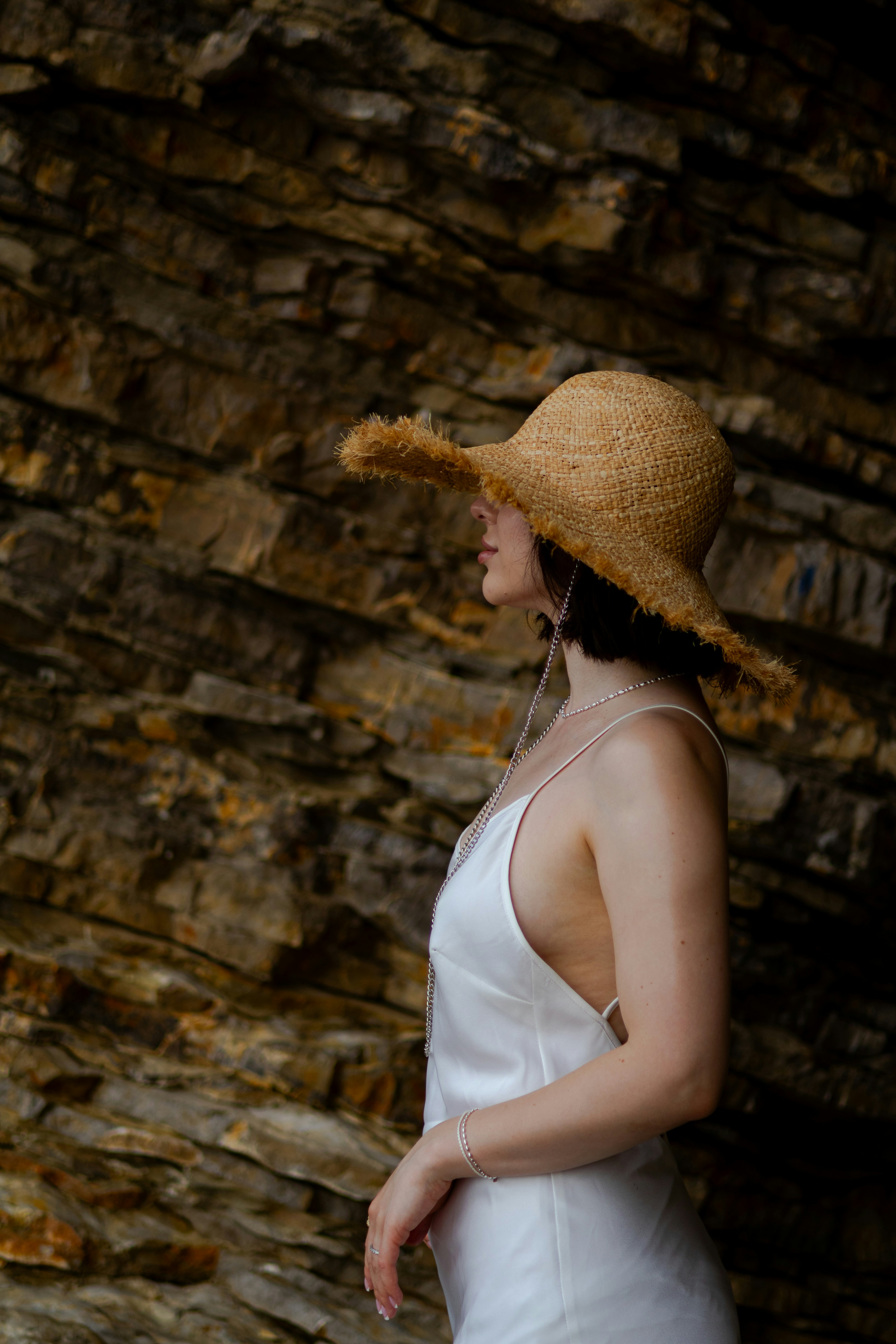 Straw Hat in Soft Light by a Weathered Wall