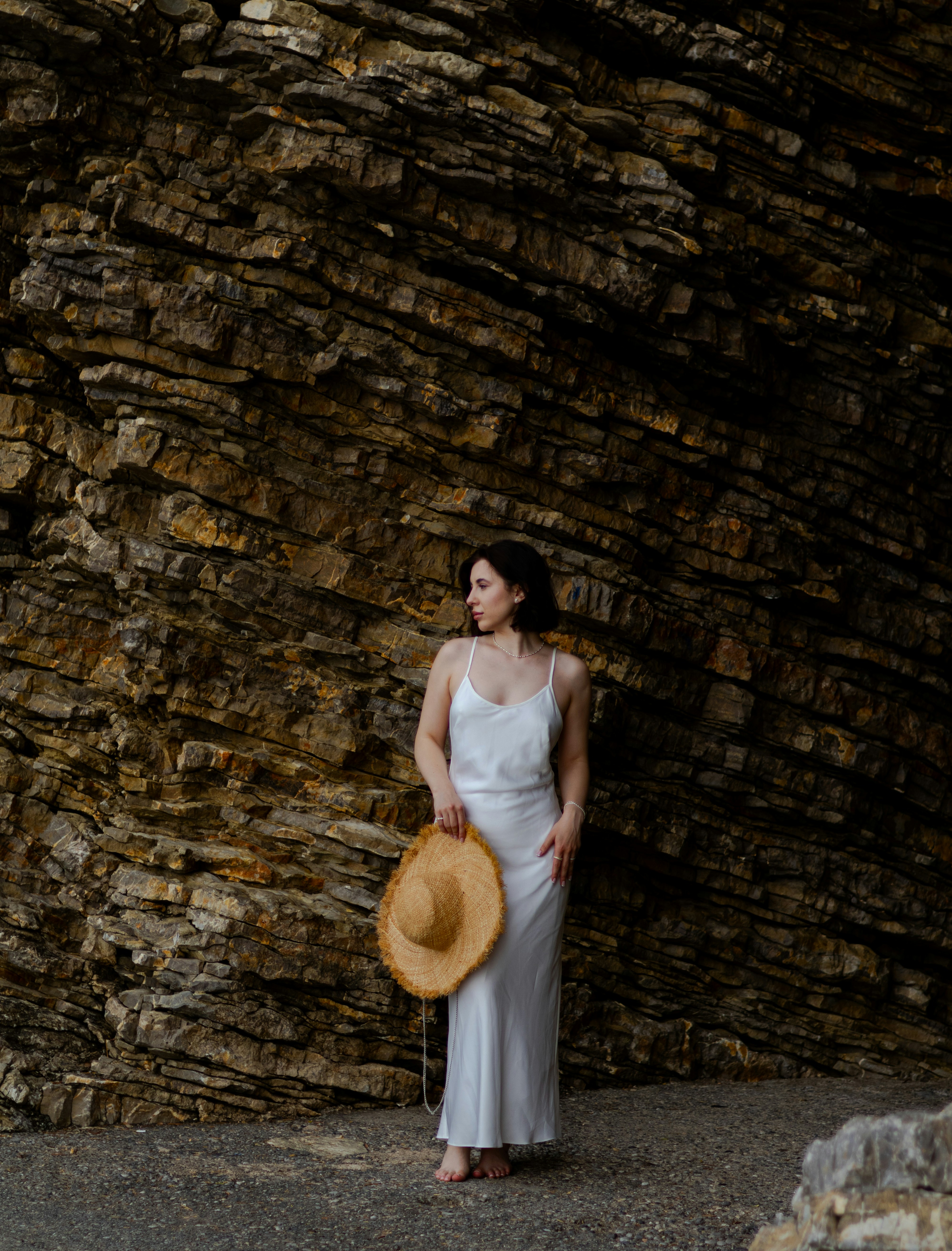 Une femme debout devant un mur de pierre photo – Image gratuite de ...