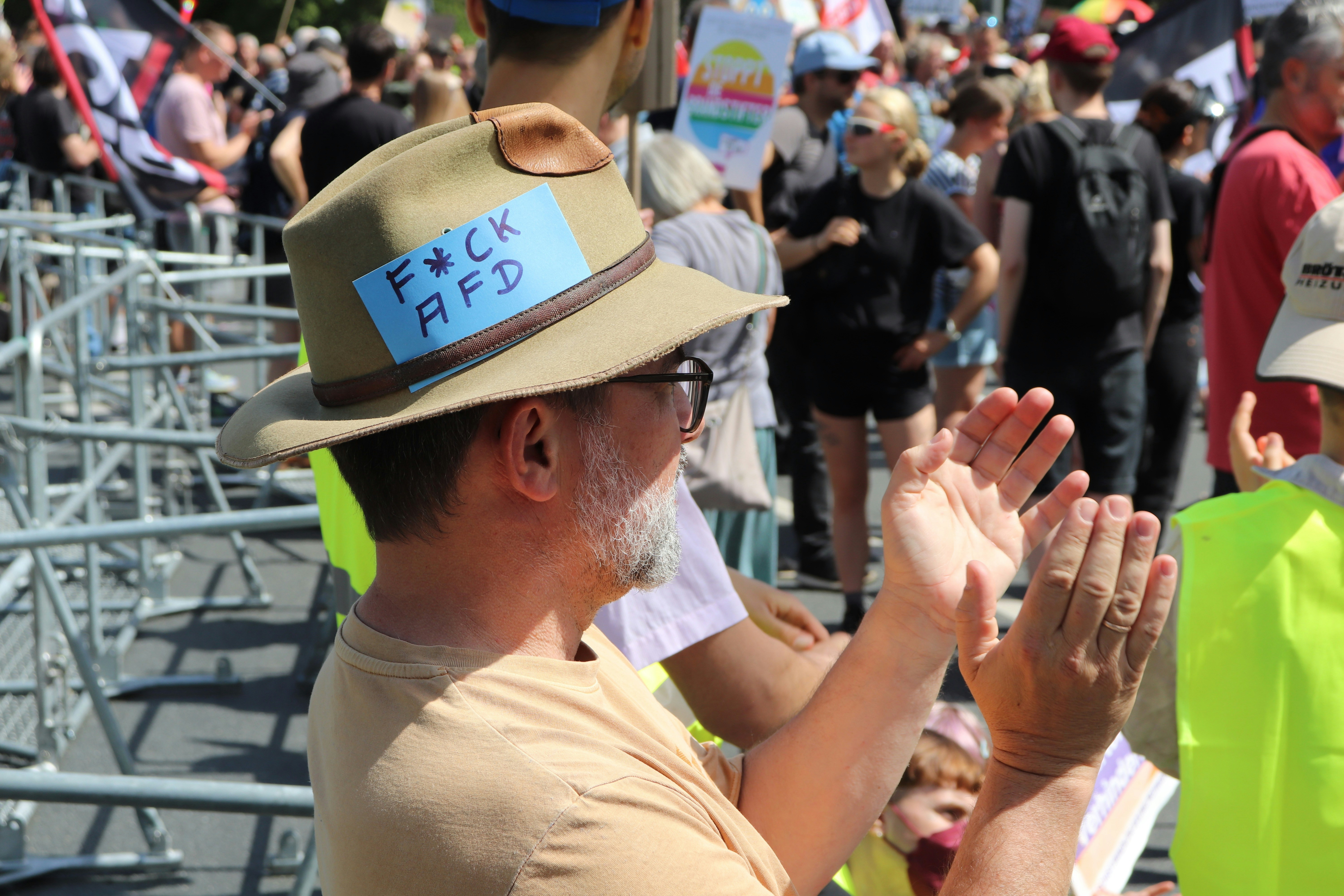 Clapping in the March: A Candid Moment Amid the Crowd
