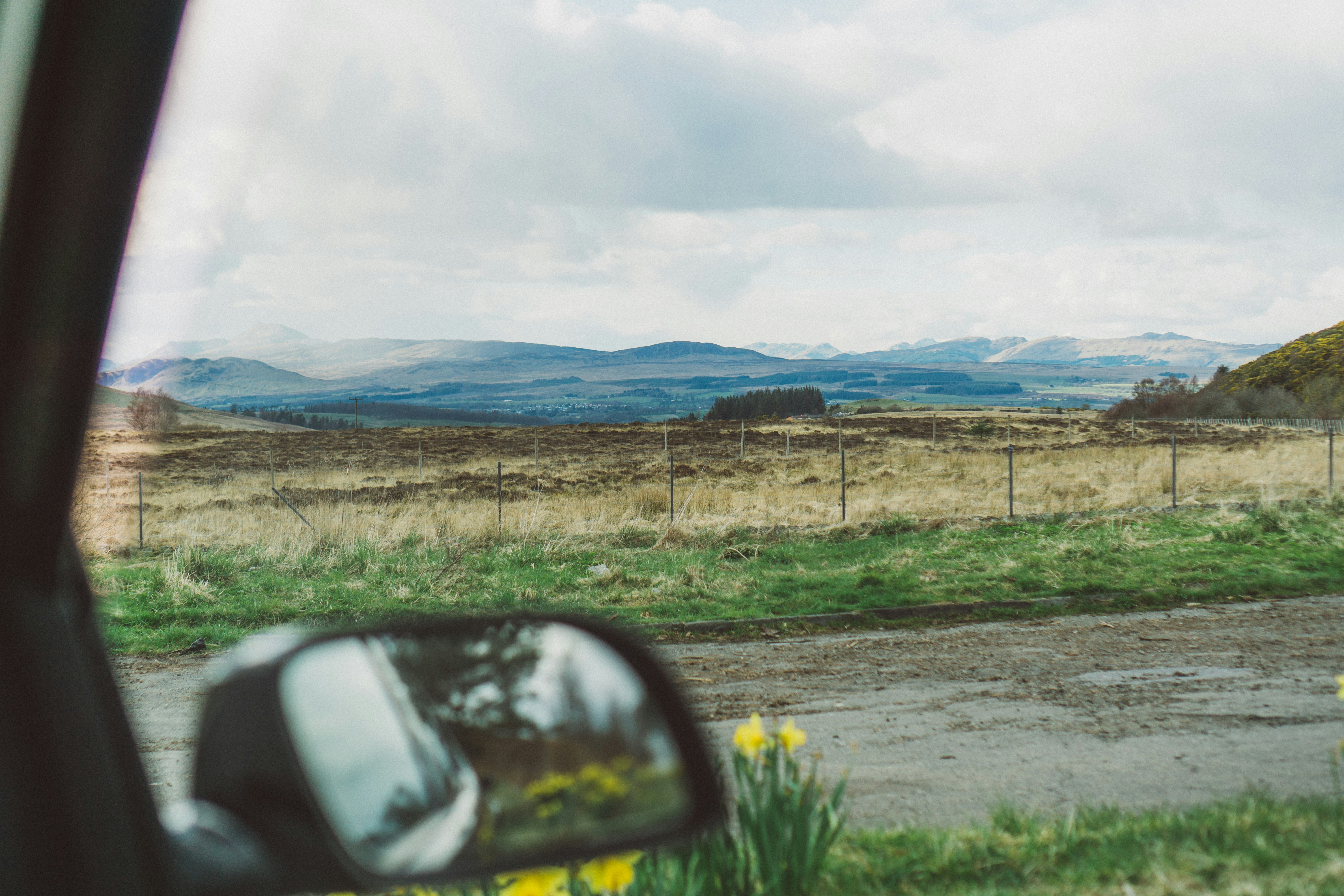 Horizon Through a Car Window: Fence Posts and Distant Hills