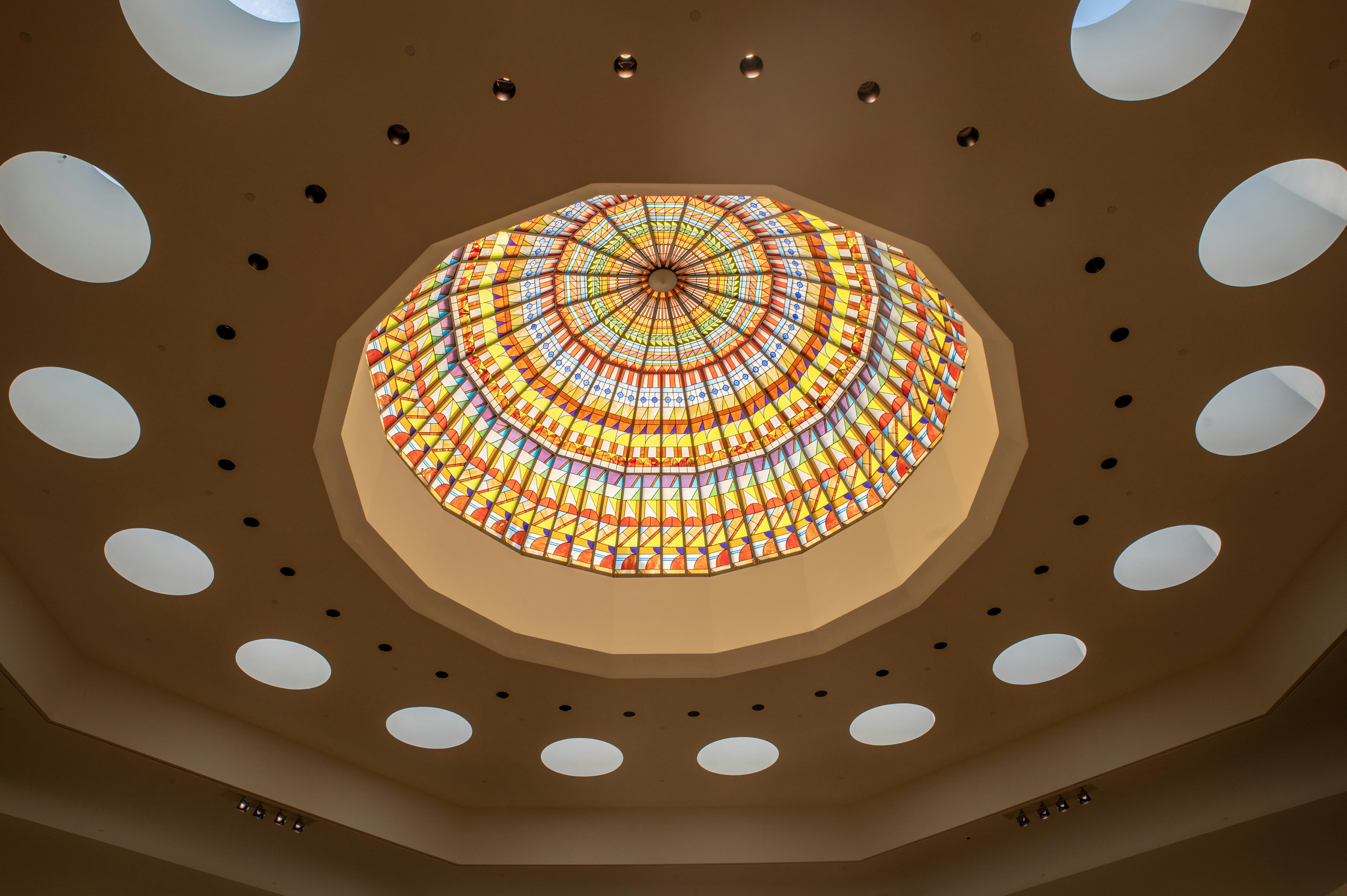 Concentric Glass Dome: Colorful Skylight Anchoring an Octagonal Atrium