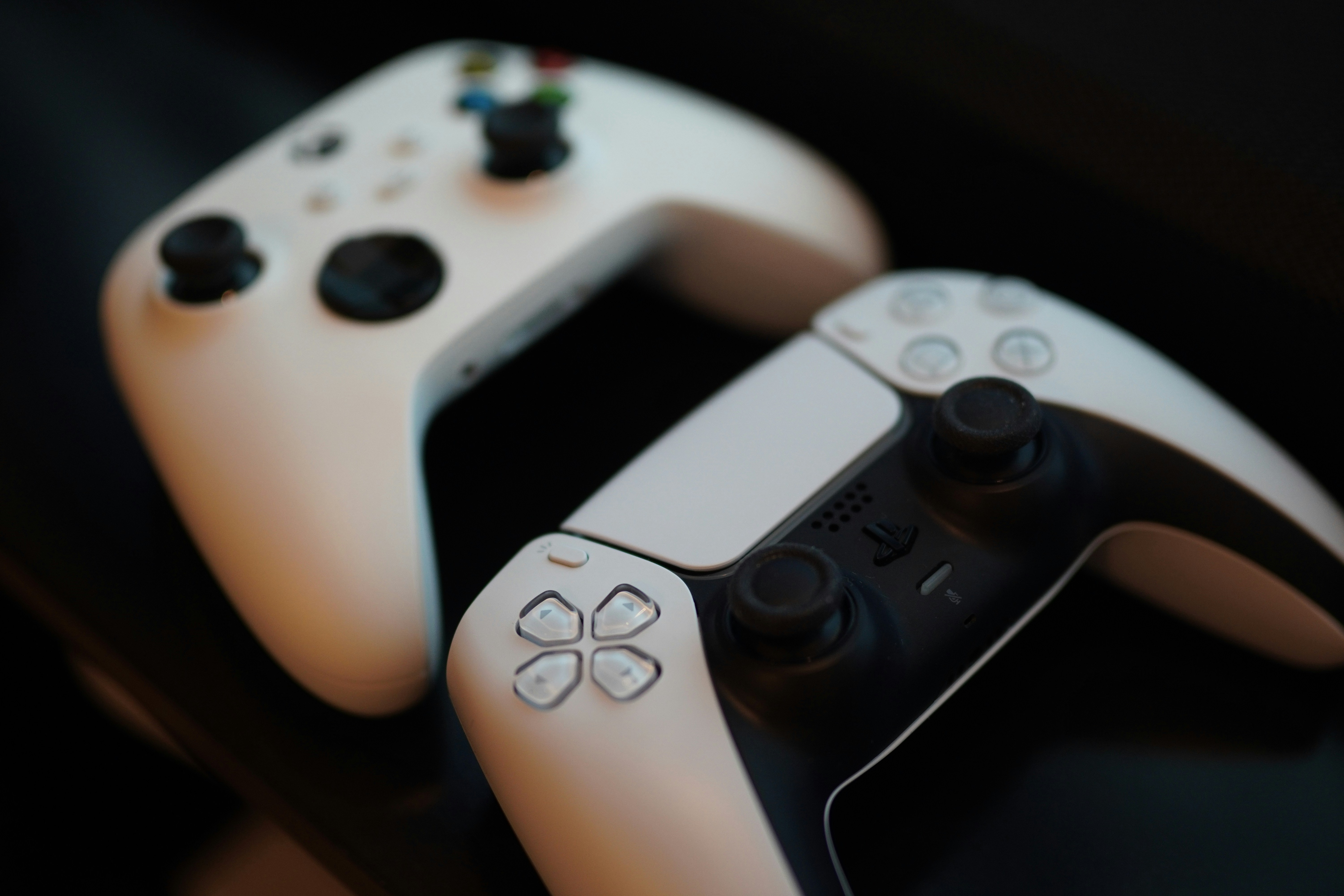 Two video game controllers sitting next to each other