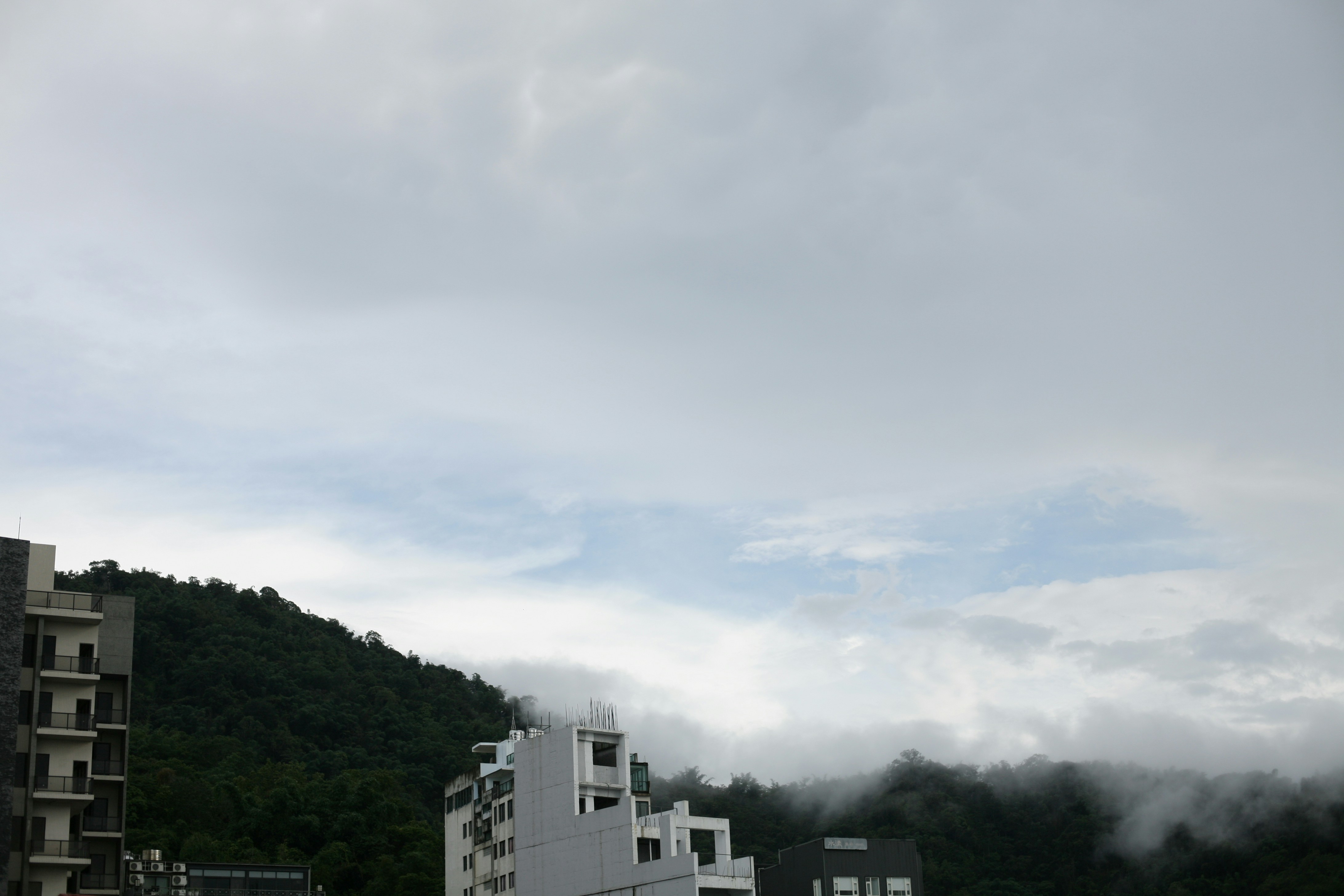Misty Crest over a Concrete Cityscape