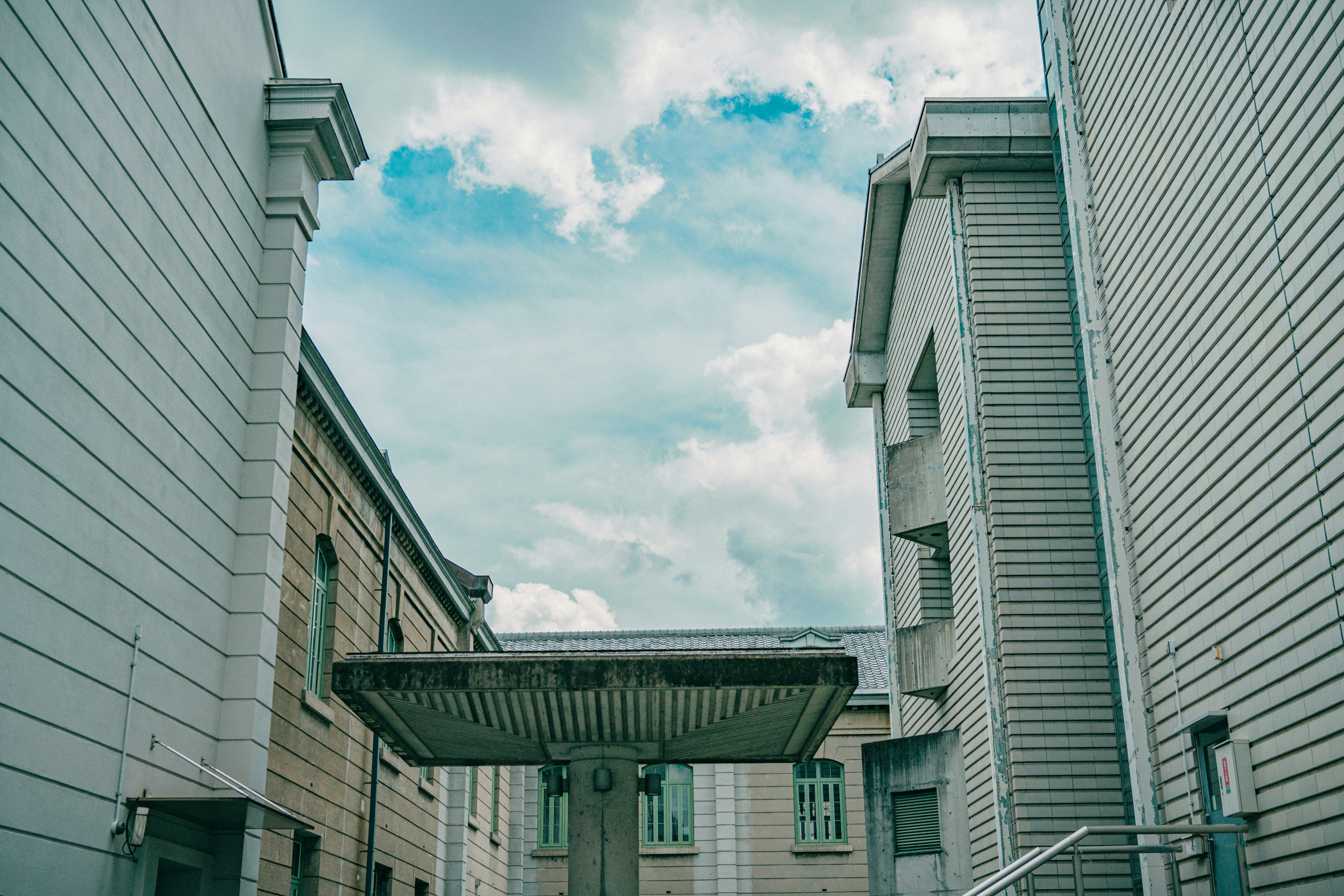 A walkway between two buildings with a sky background photo – Free ...