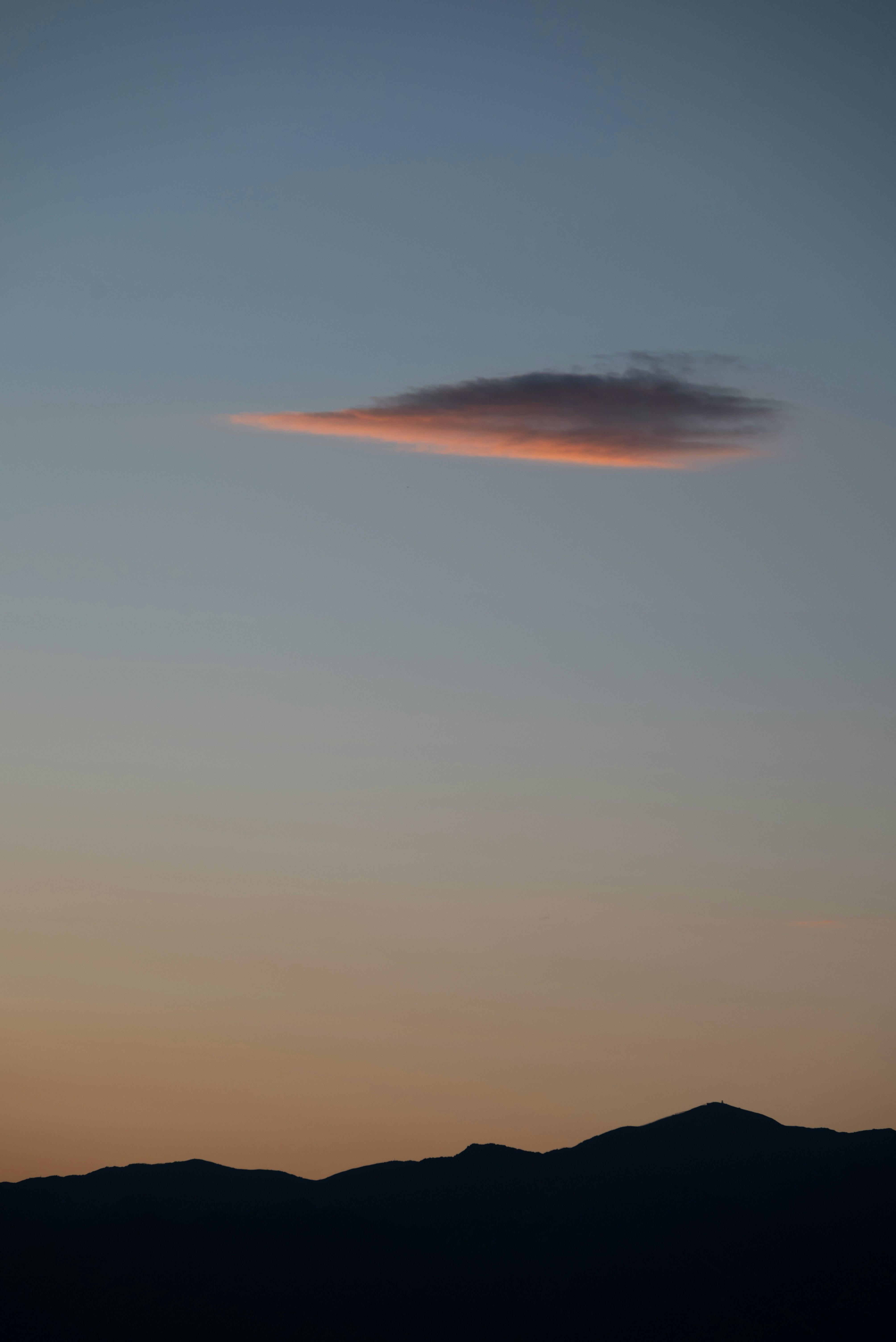 Ember Cloud Over the Silent Ridge at Dusk