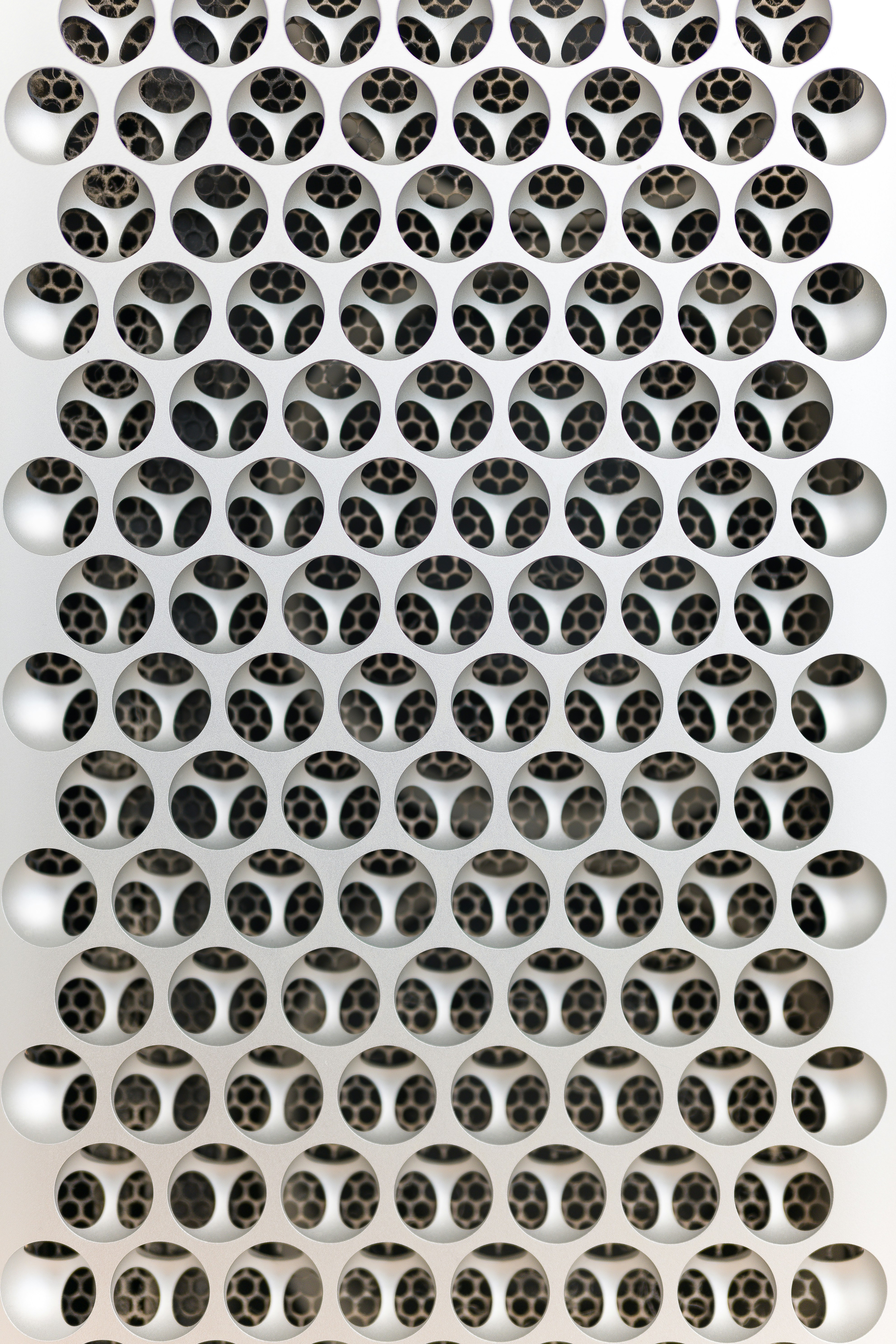 A picture of a bunch of holes in the side of a wall photo – Free ...