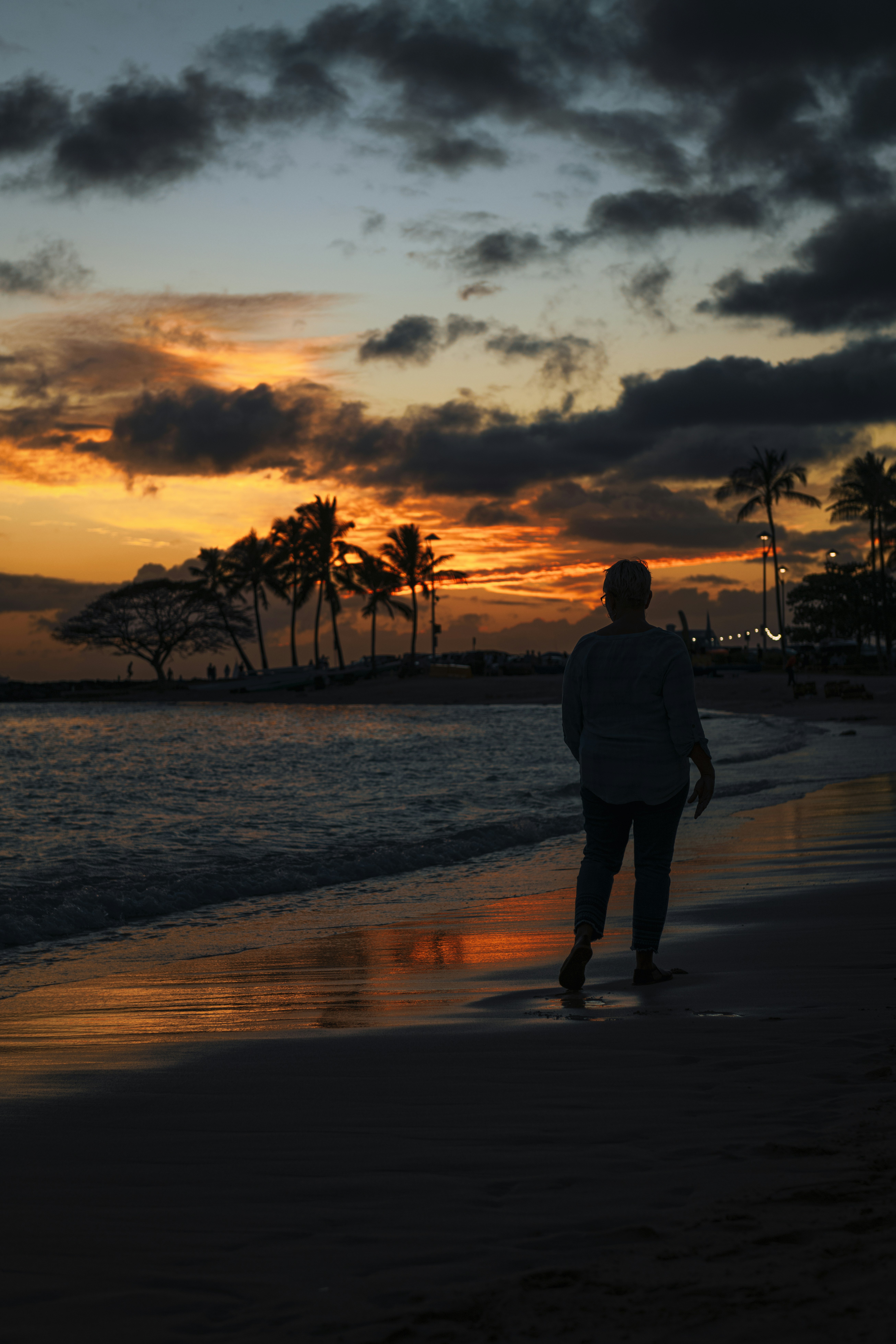 A person walking on a beach at sunset photo – Free Beach Image on Unsplash