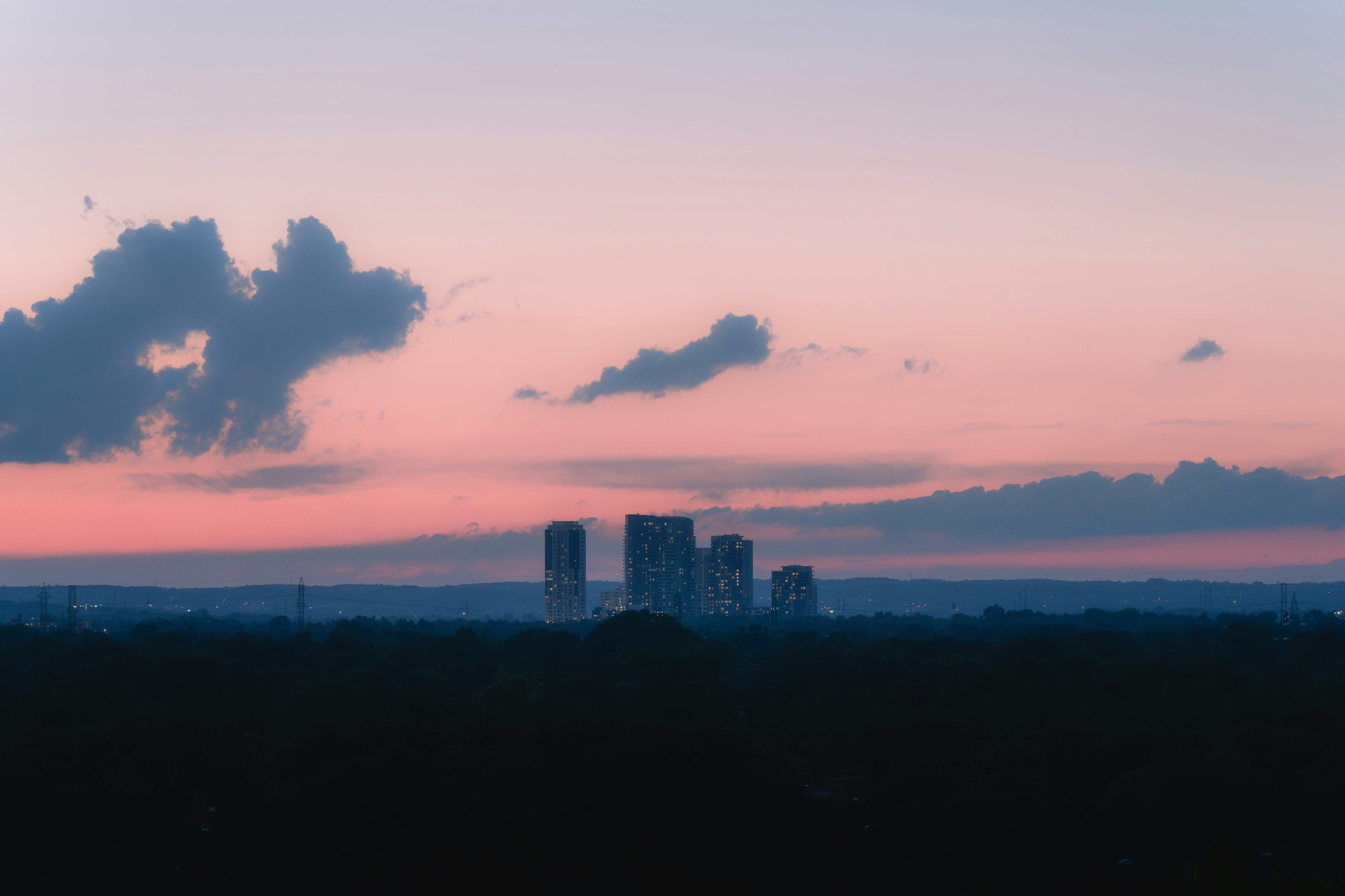 A view of a city from a distance at sunset photo – Free City Image on ...
