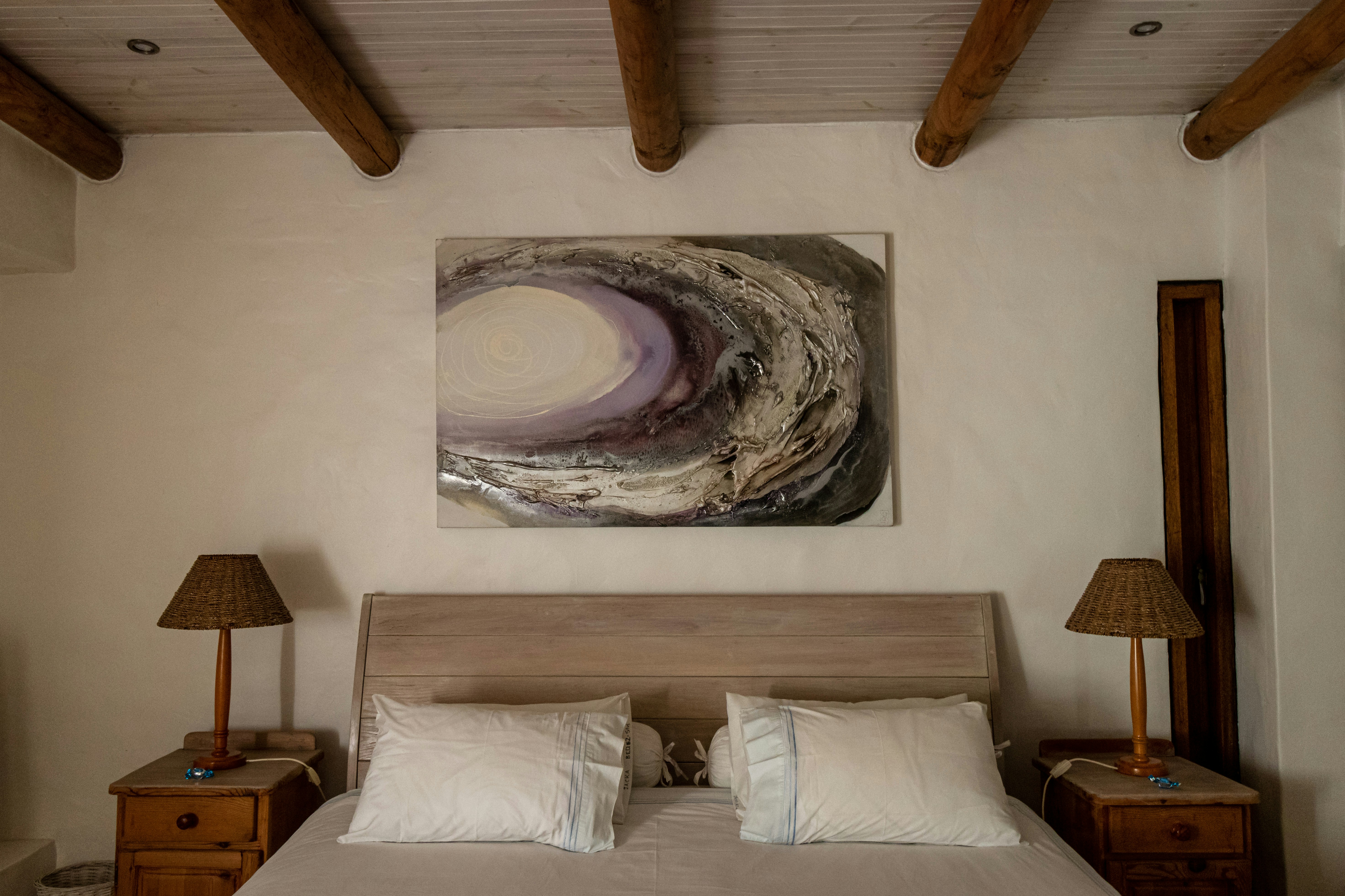 Swirl Above the Bed: A Calm Composition in Timber and Linen
