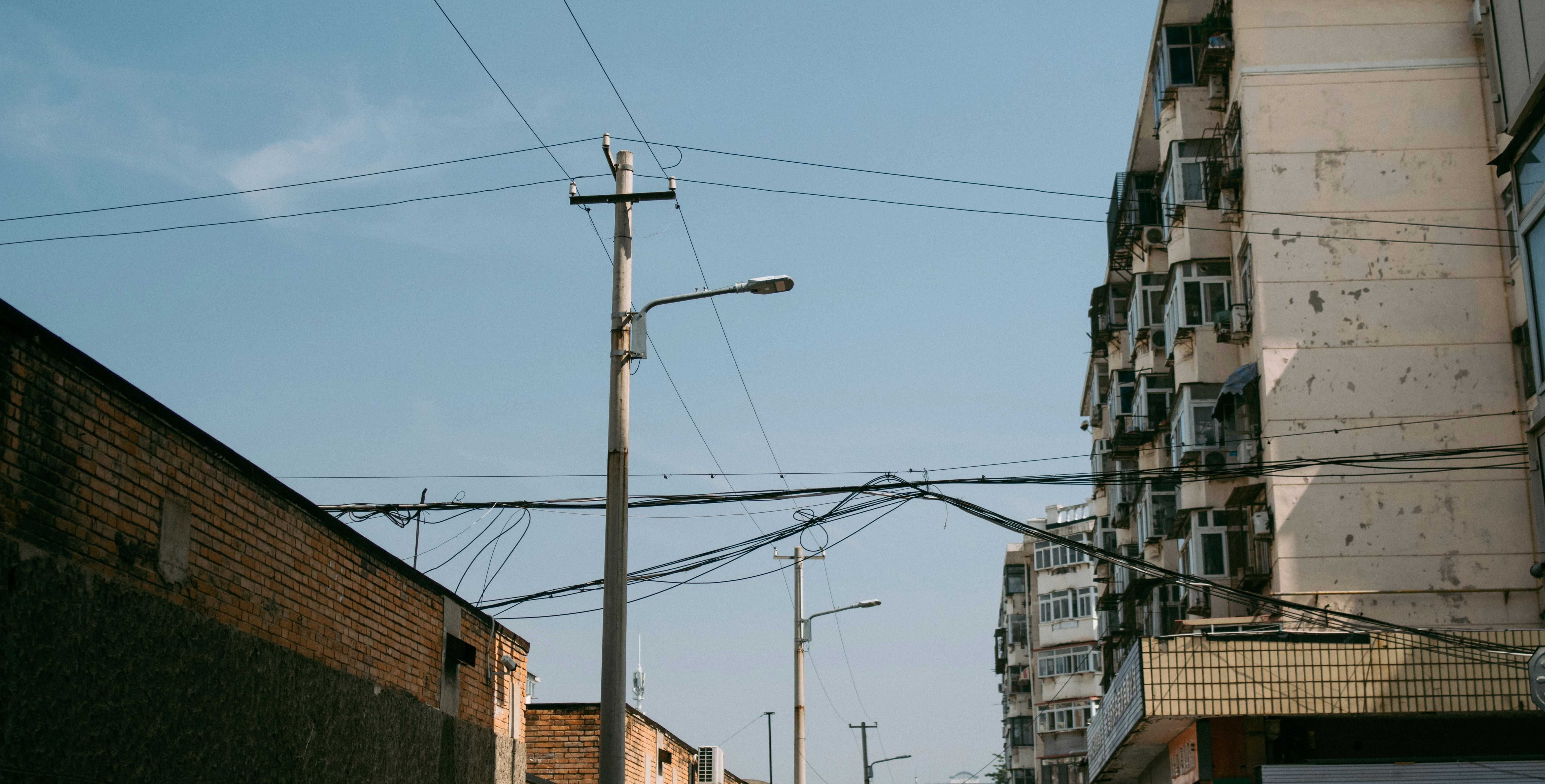 A view of a city street with a building in the background photo – Free ...