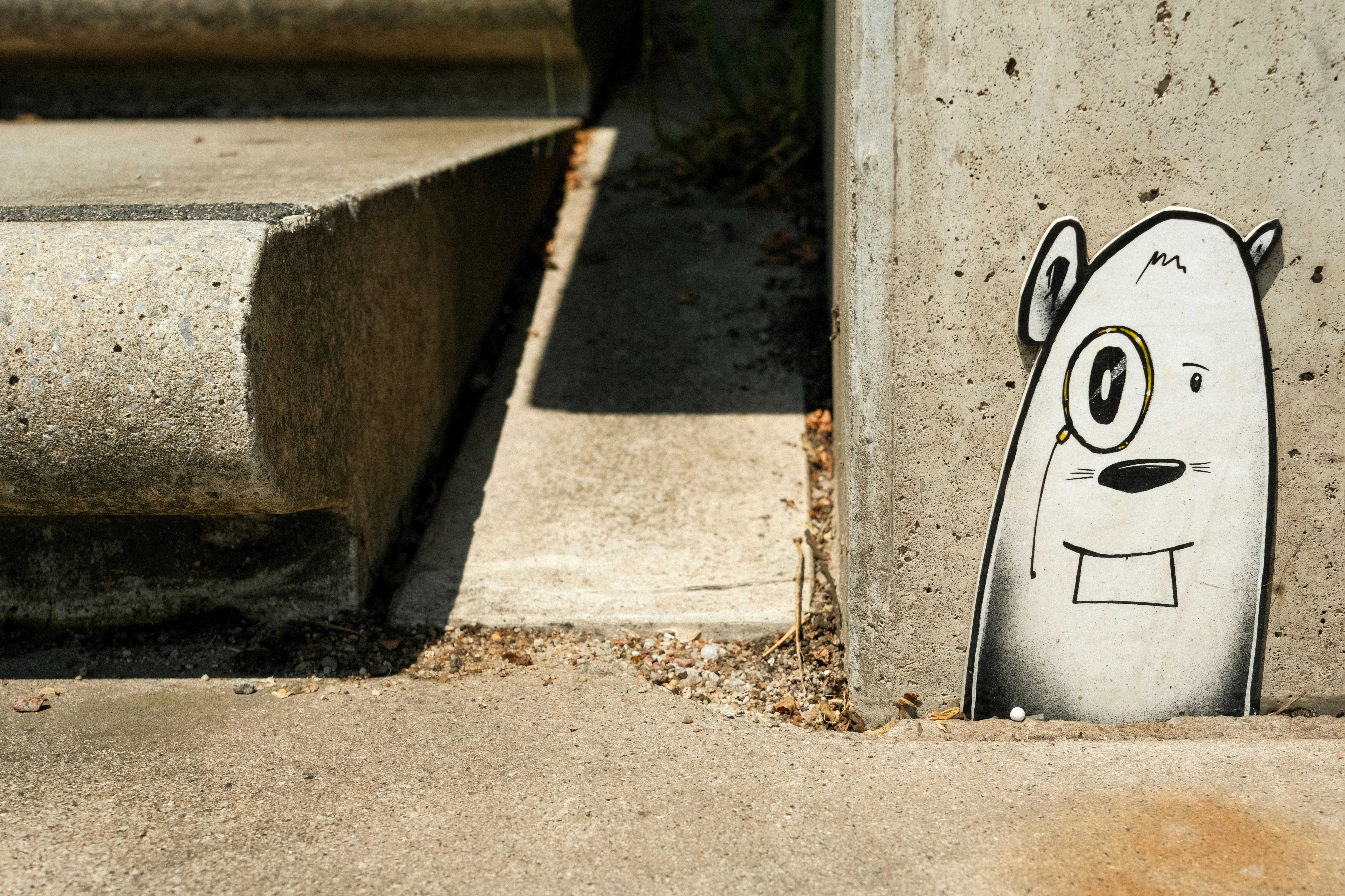 Concrete Steps Meet a Cartoon Mask: A Quiet Street Corner