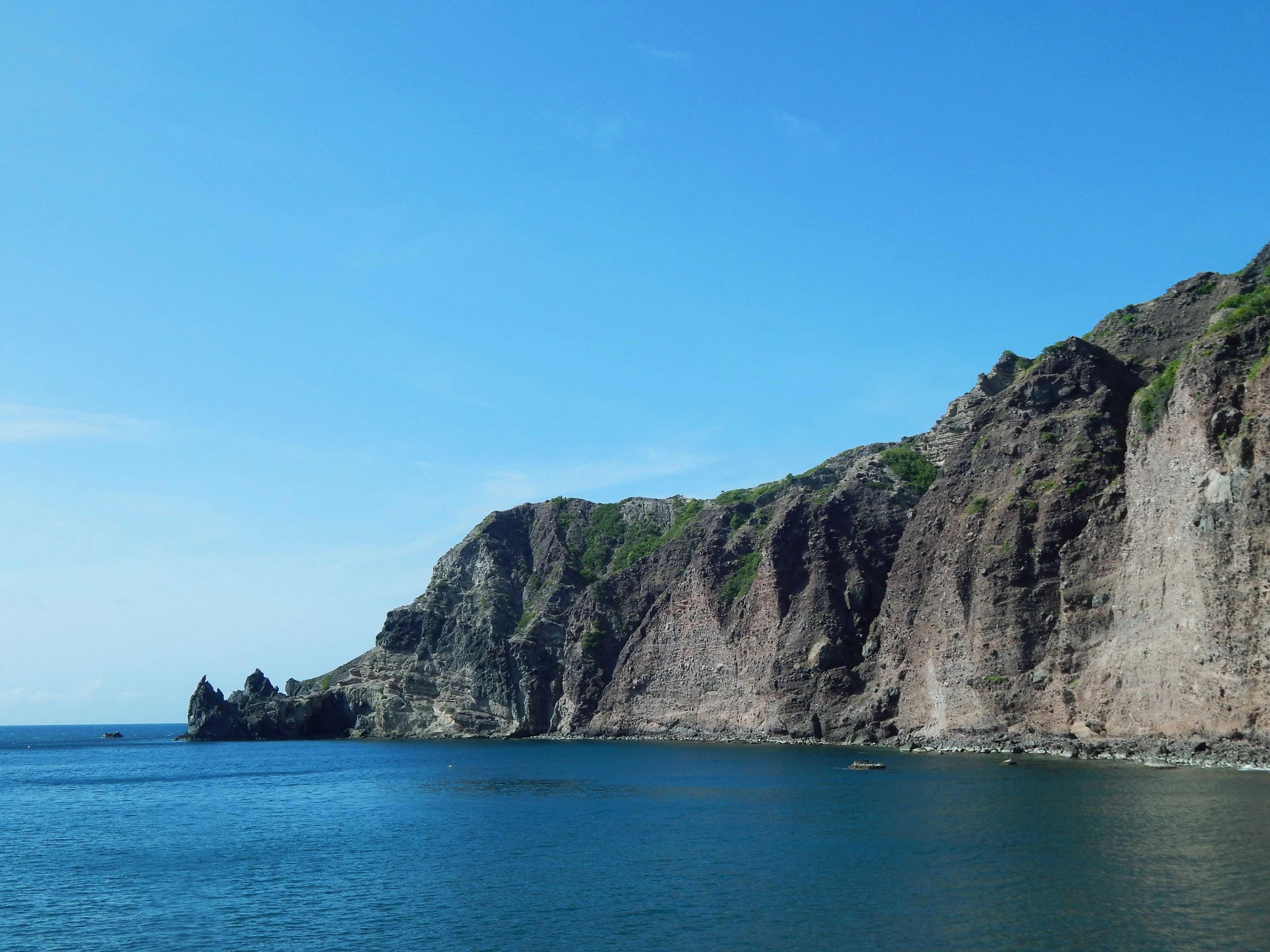 Cliff Ridge Against a Quiet Sapphire Sea
