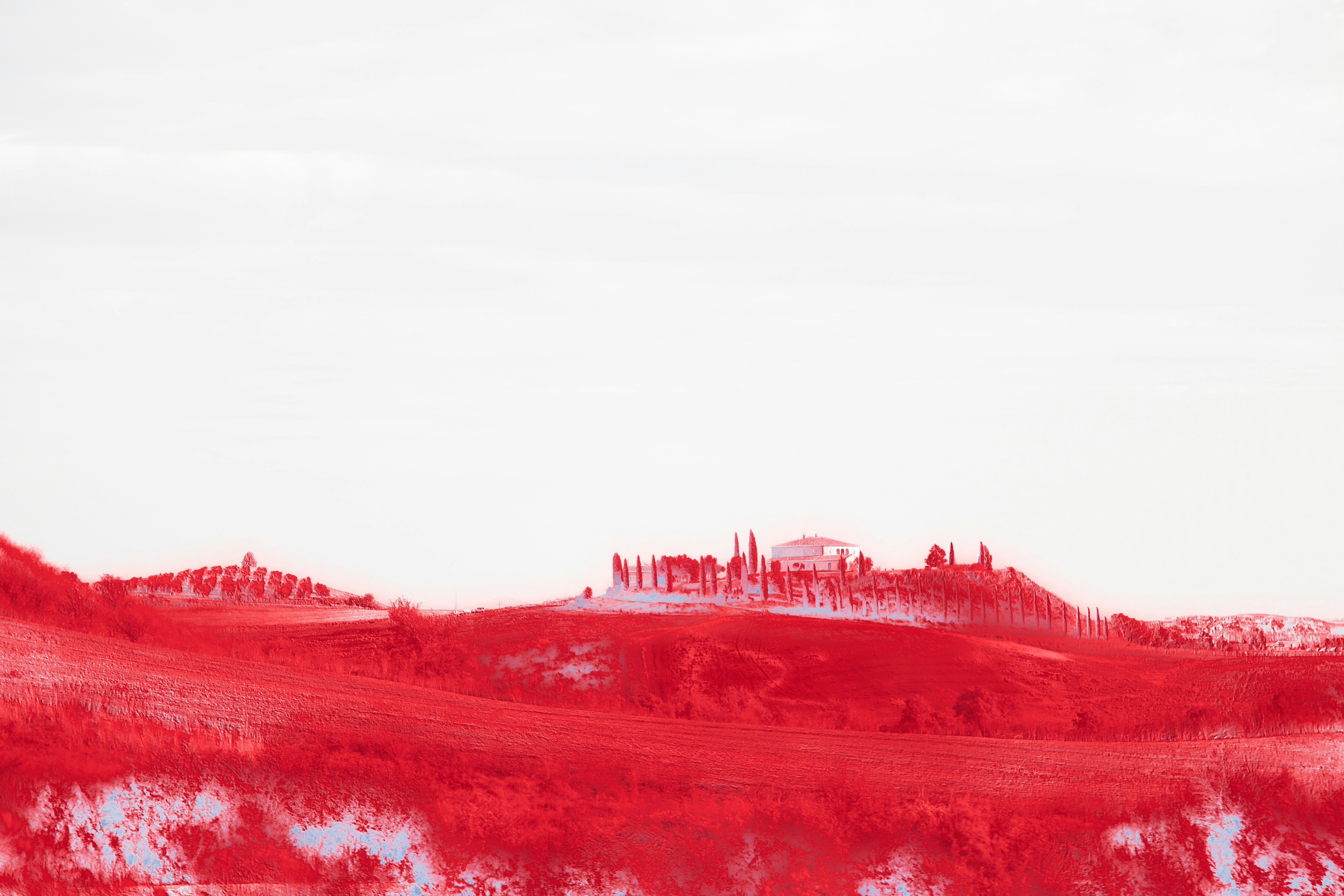 A painting of a red hill with a white sky in the background photo ...