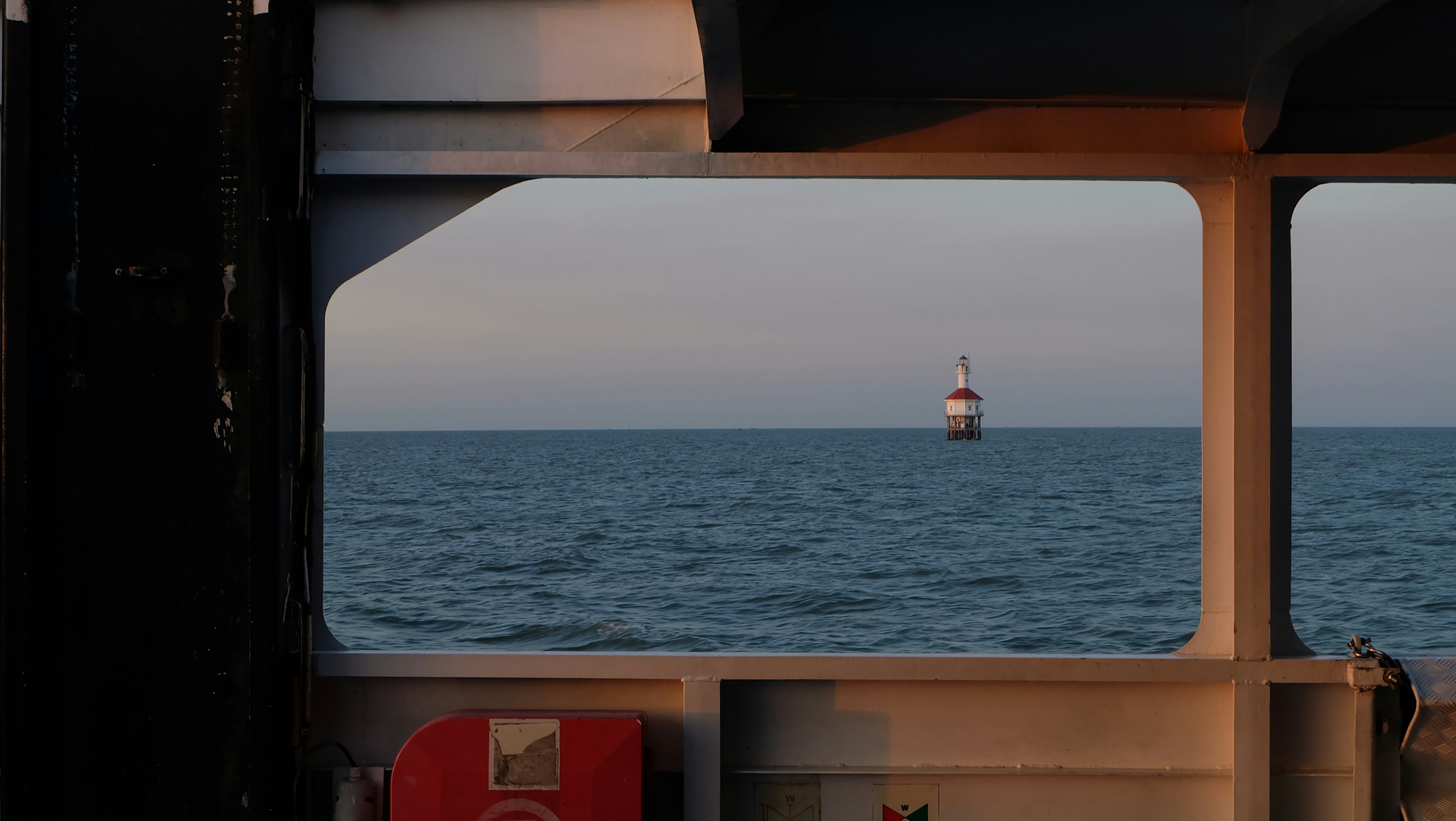 Beacon on the Blue Edge: a lighthouse framed by steel and sea
