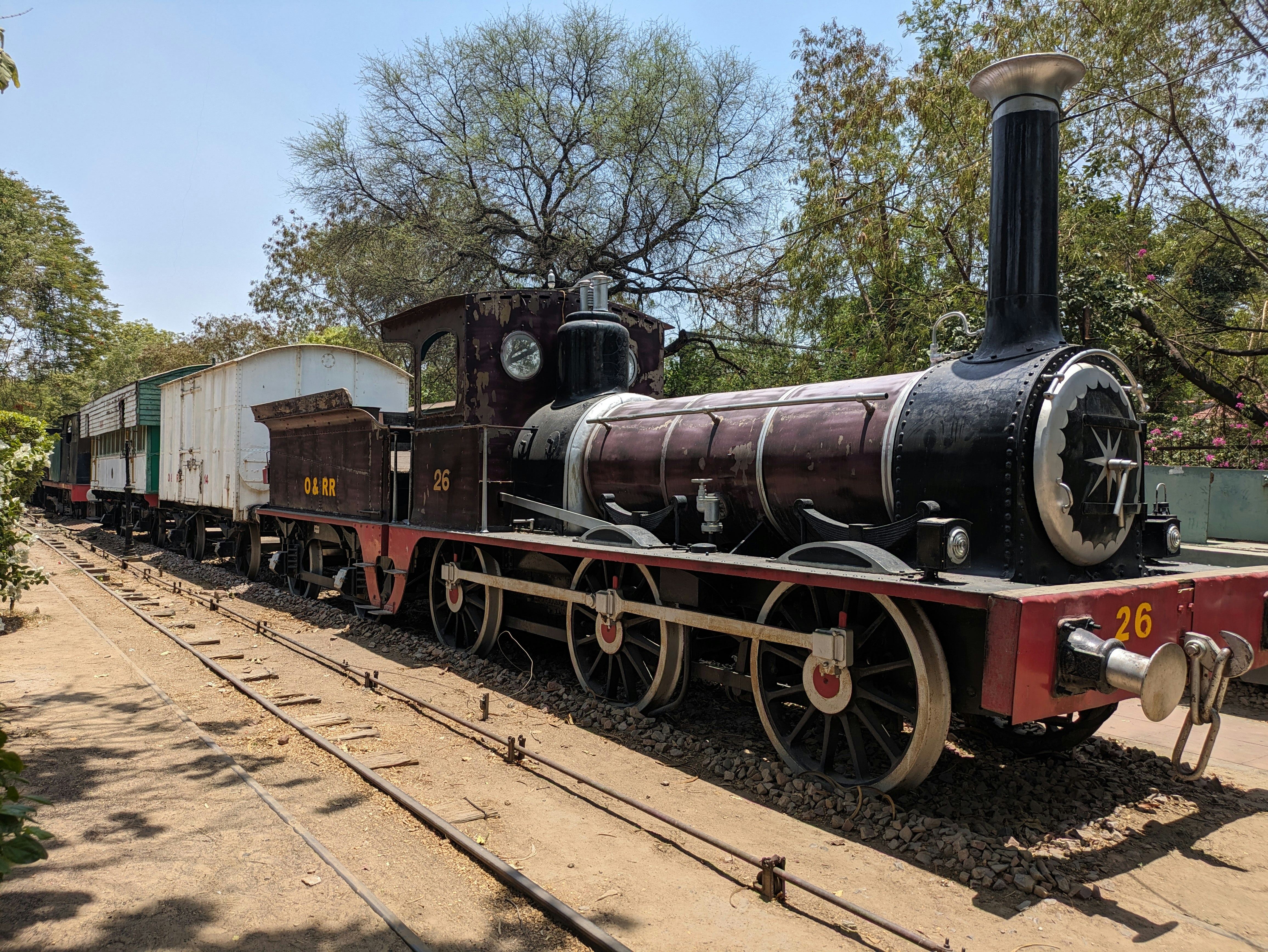 Sunlit Relic on Rails: A Vintage Steam Engine at Rest
