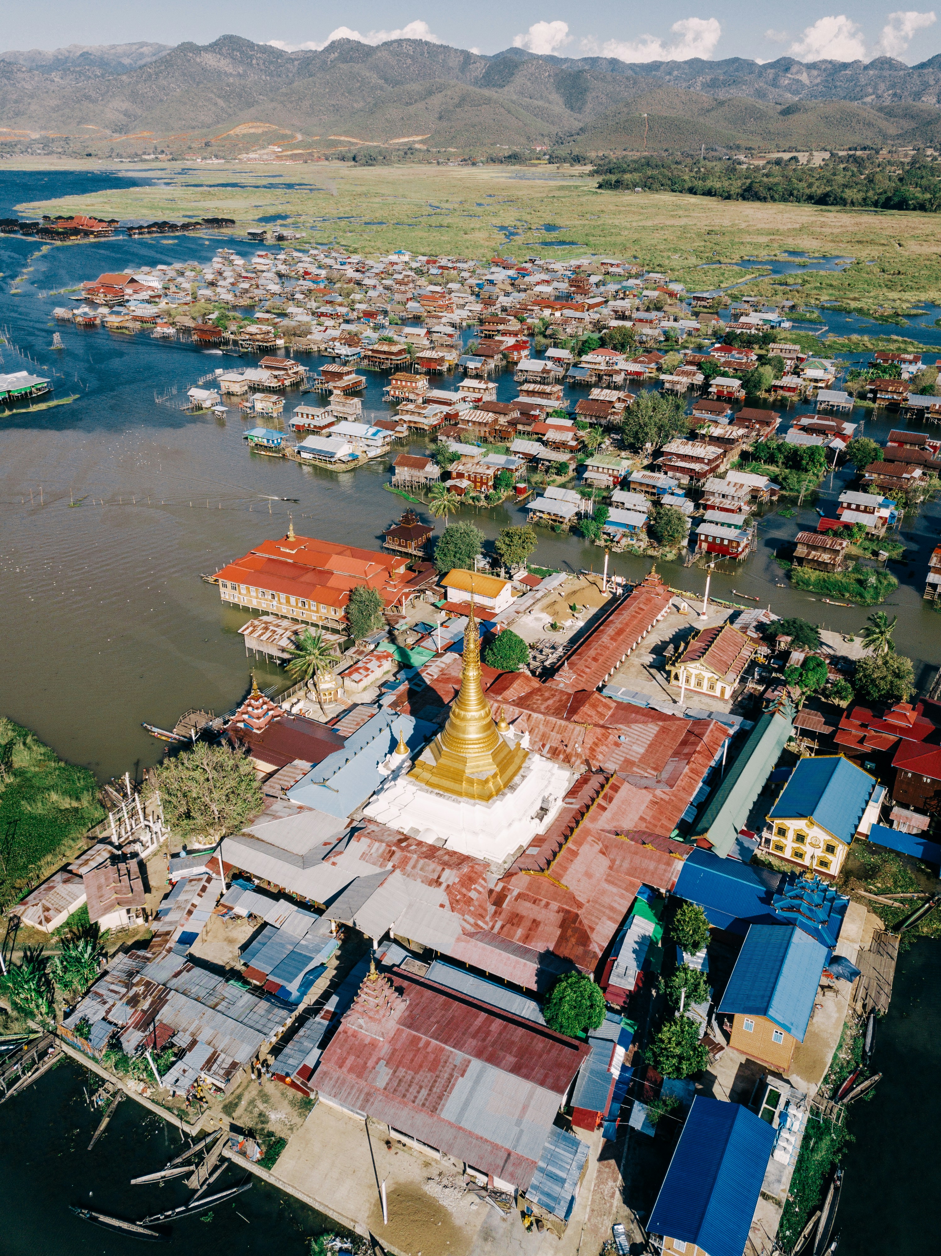 An aerial view of a village with a river running through it photo ...