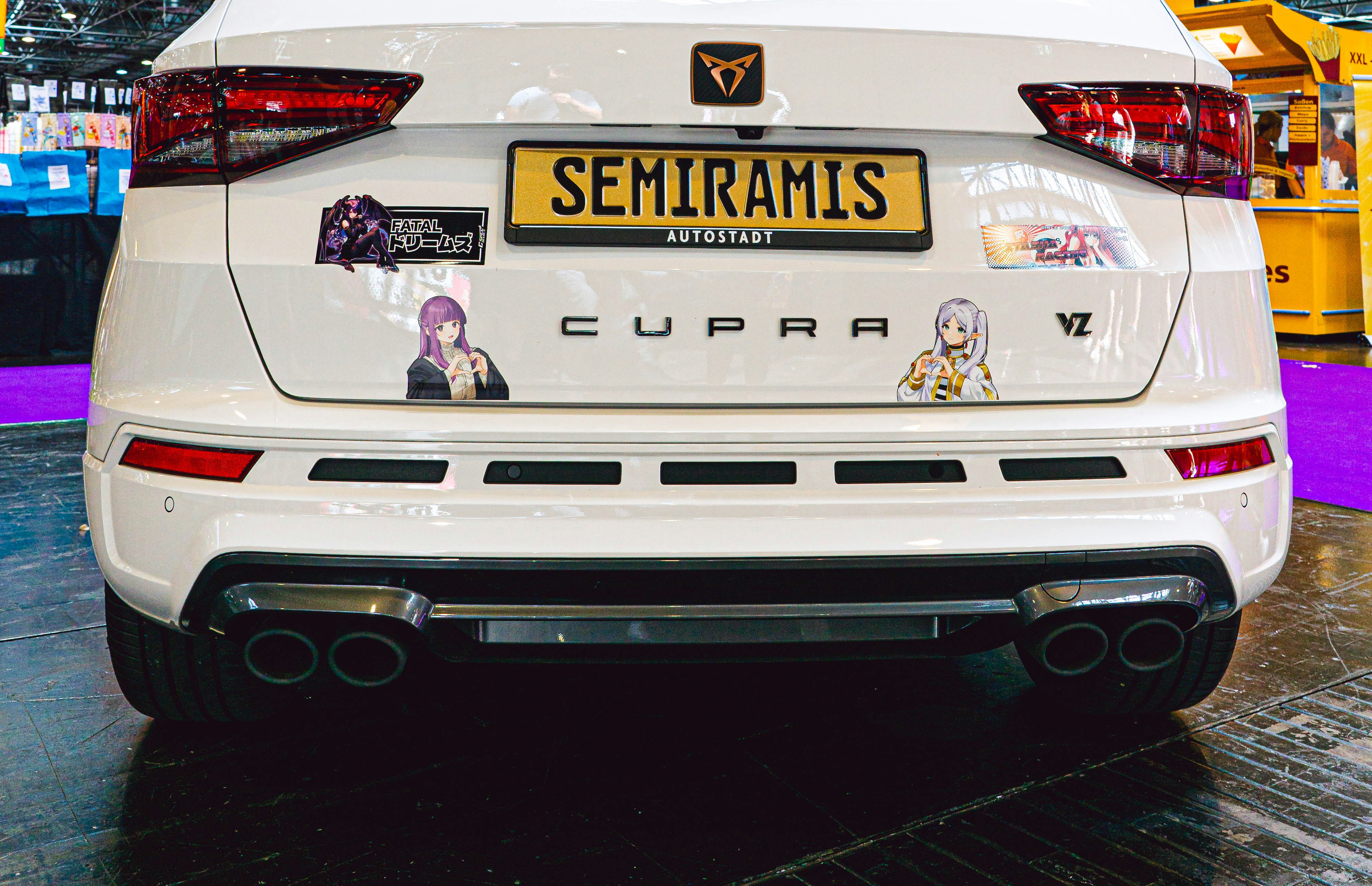 Stickered Cupra: Anime Accent Decals Illuminate a White Rear at the Auto Show