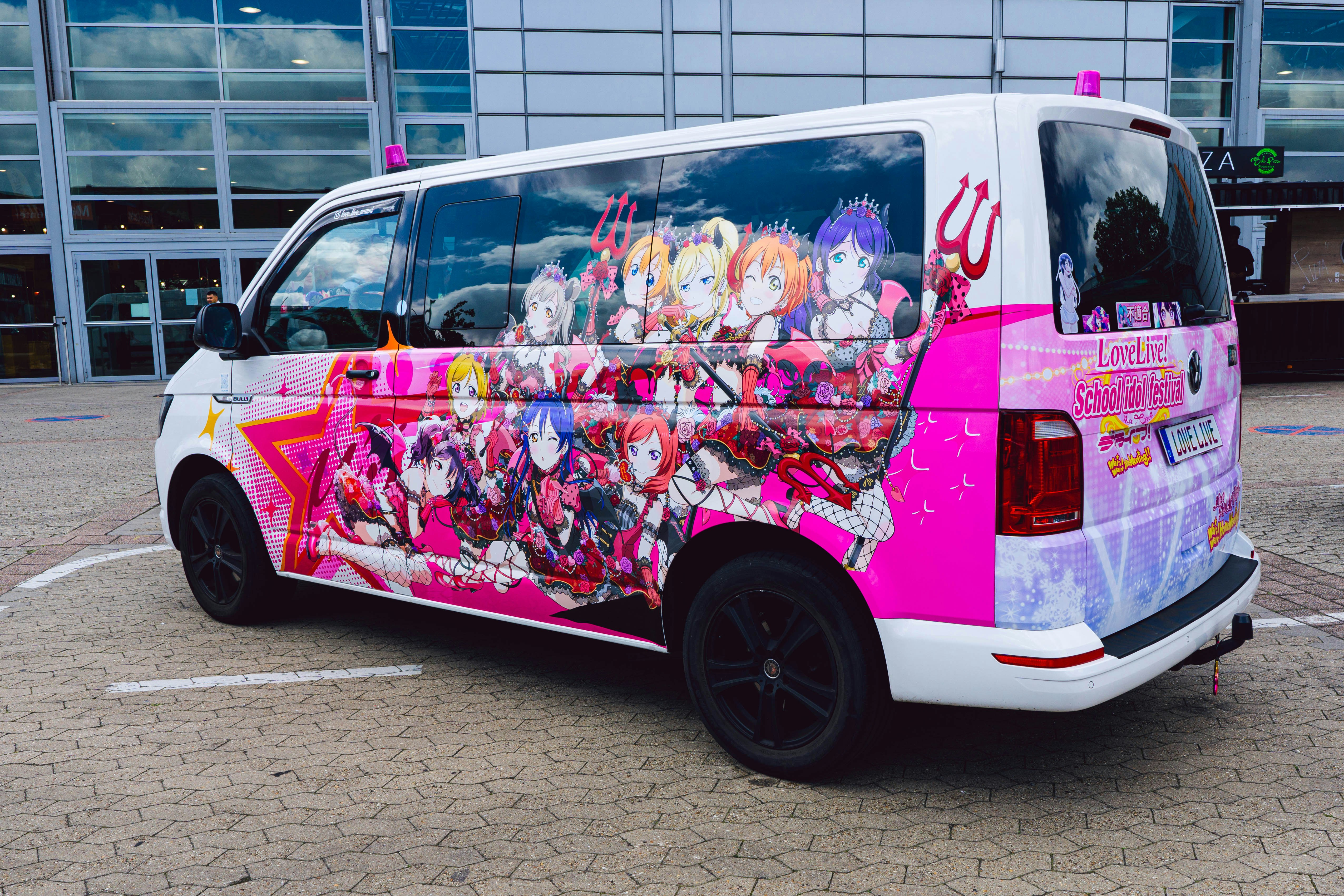 A van with a lot of anime characters painted on it photo – Free Itasha ...