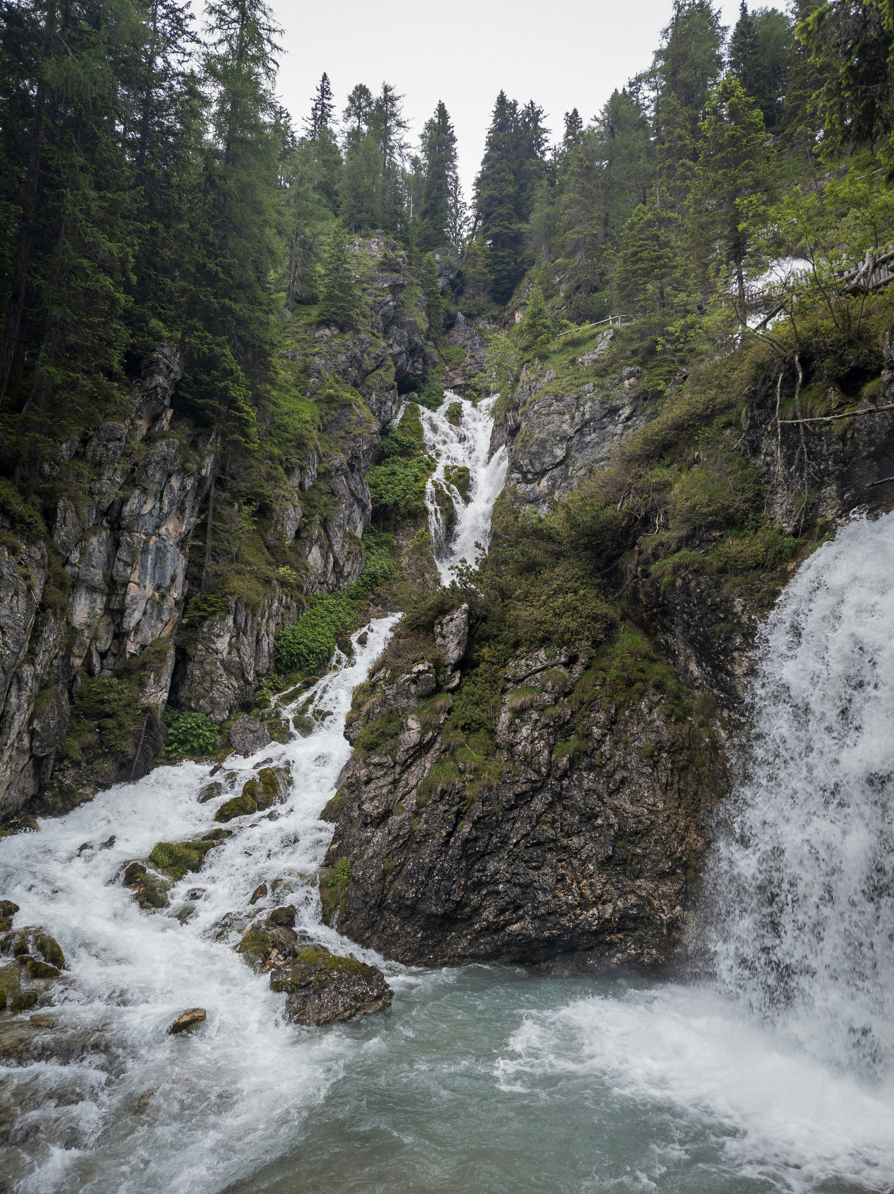 A waterfall with a waterfall cascading down the side of it photo – Free ...