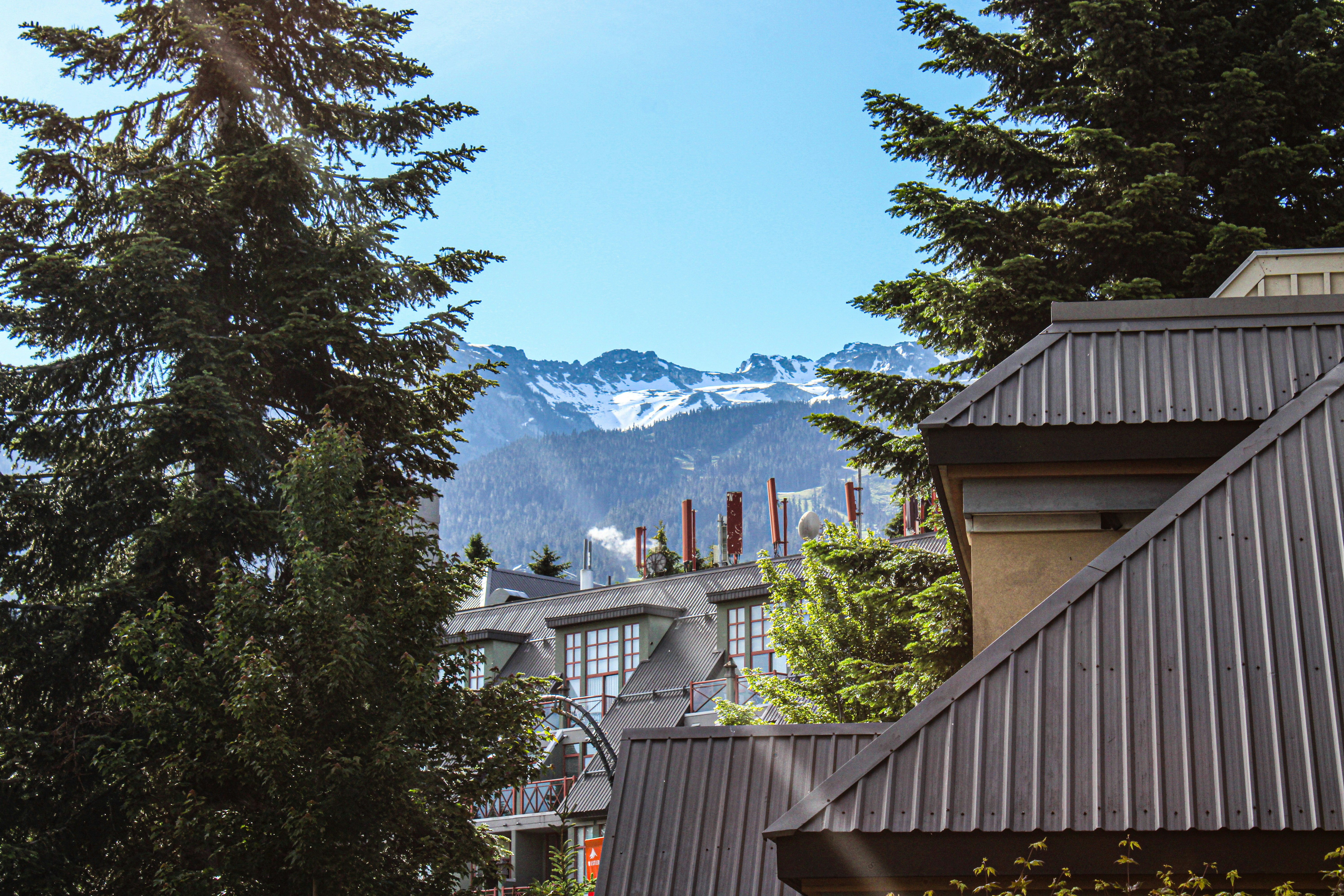 Alpine Rooftops Framing a Snow-Dusted Ridge