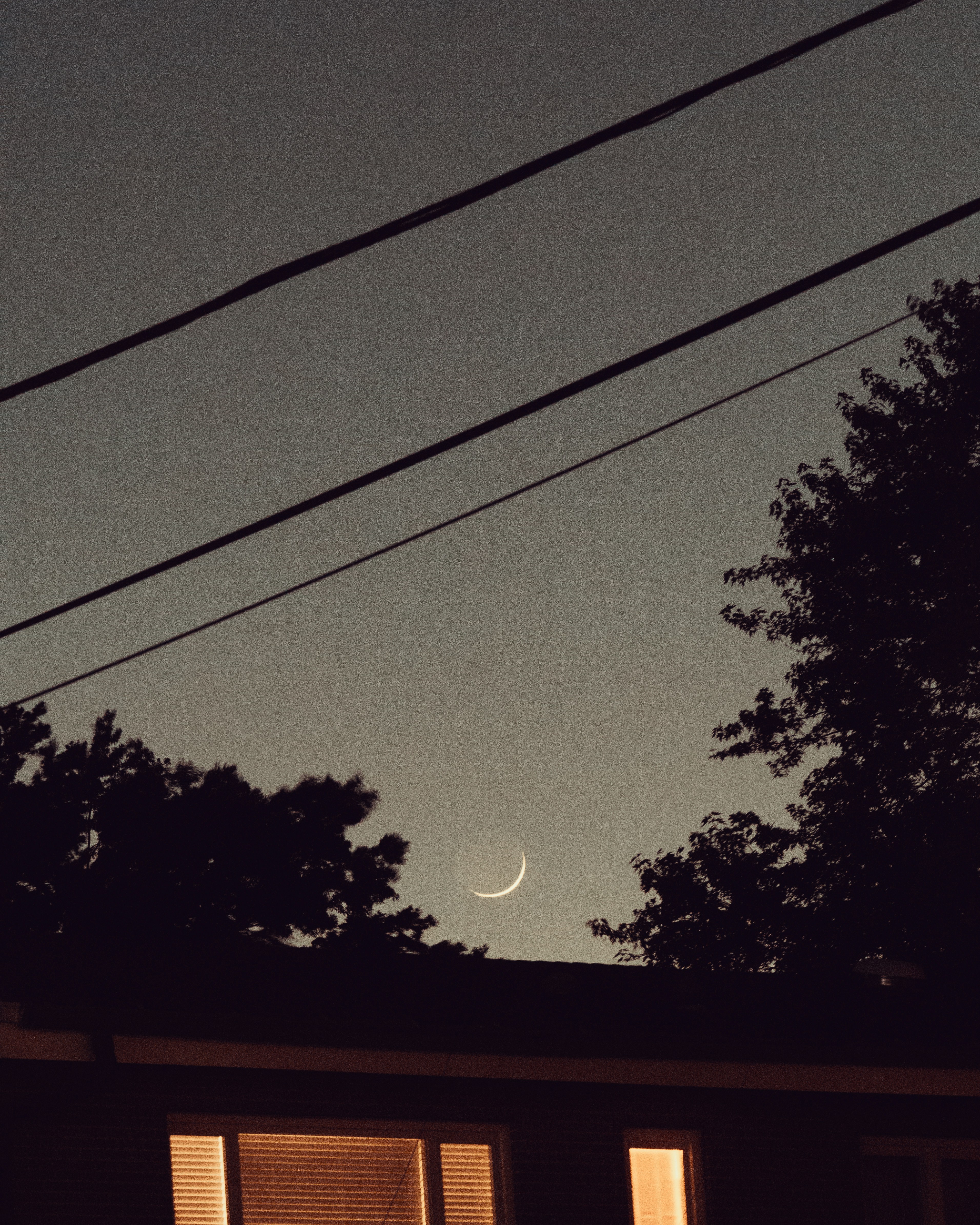 A view of the moon through the window of a house photo – Free Night ...
