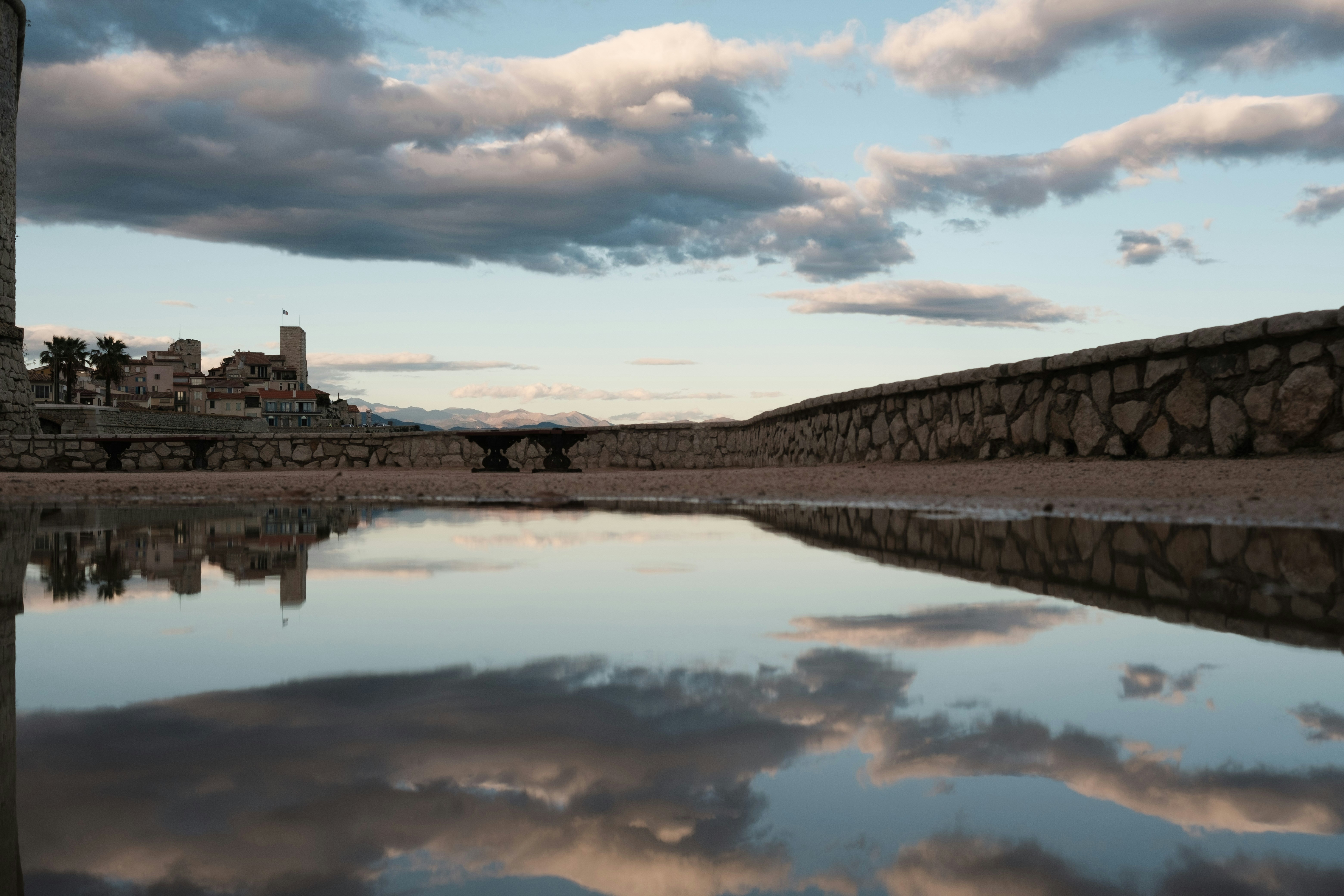 A reflection of a clock tower in the water photo – Free Antibes Image ...