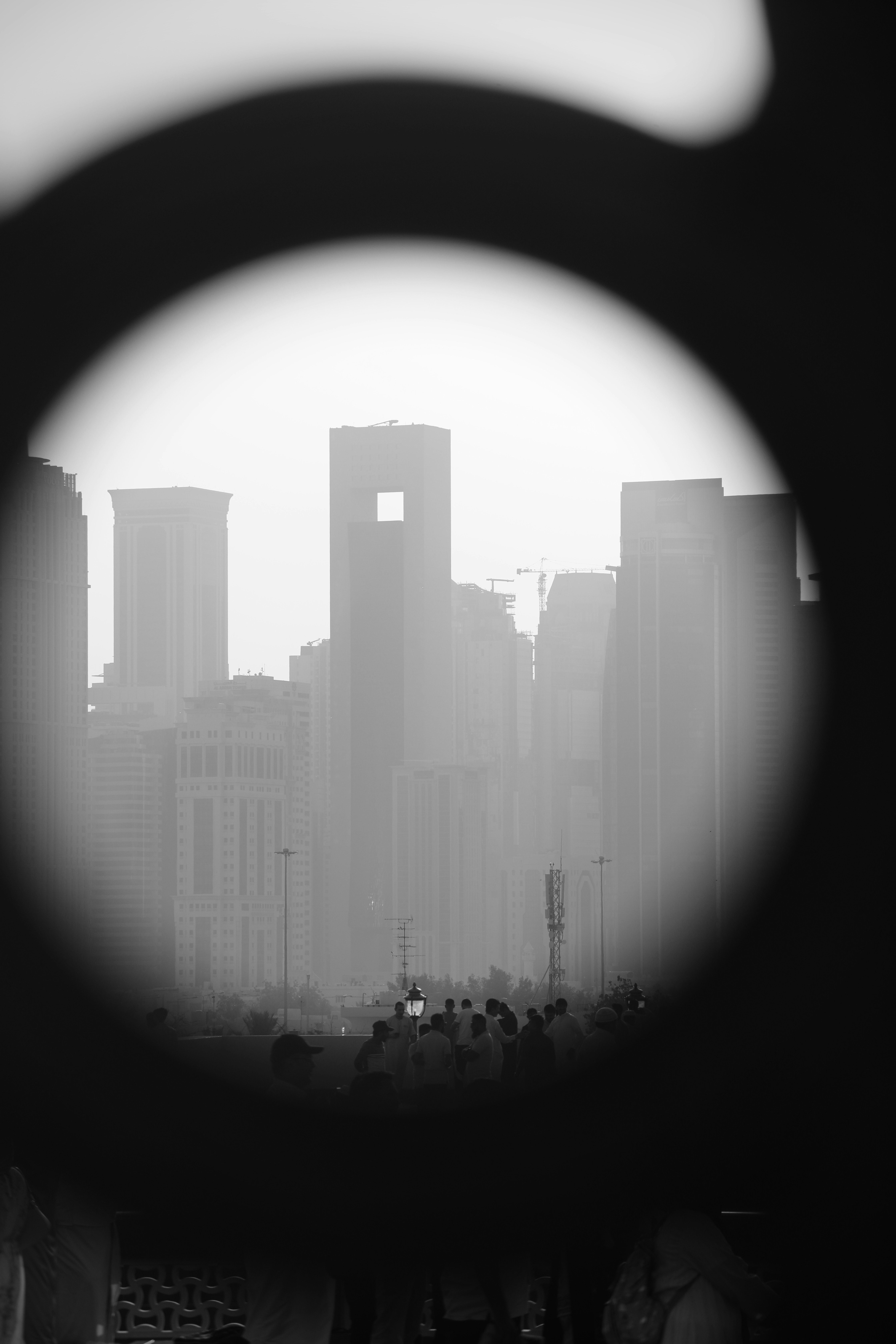 Through the Ring: City Towers Framed by a Circular Aperture