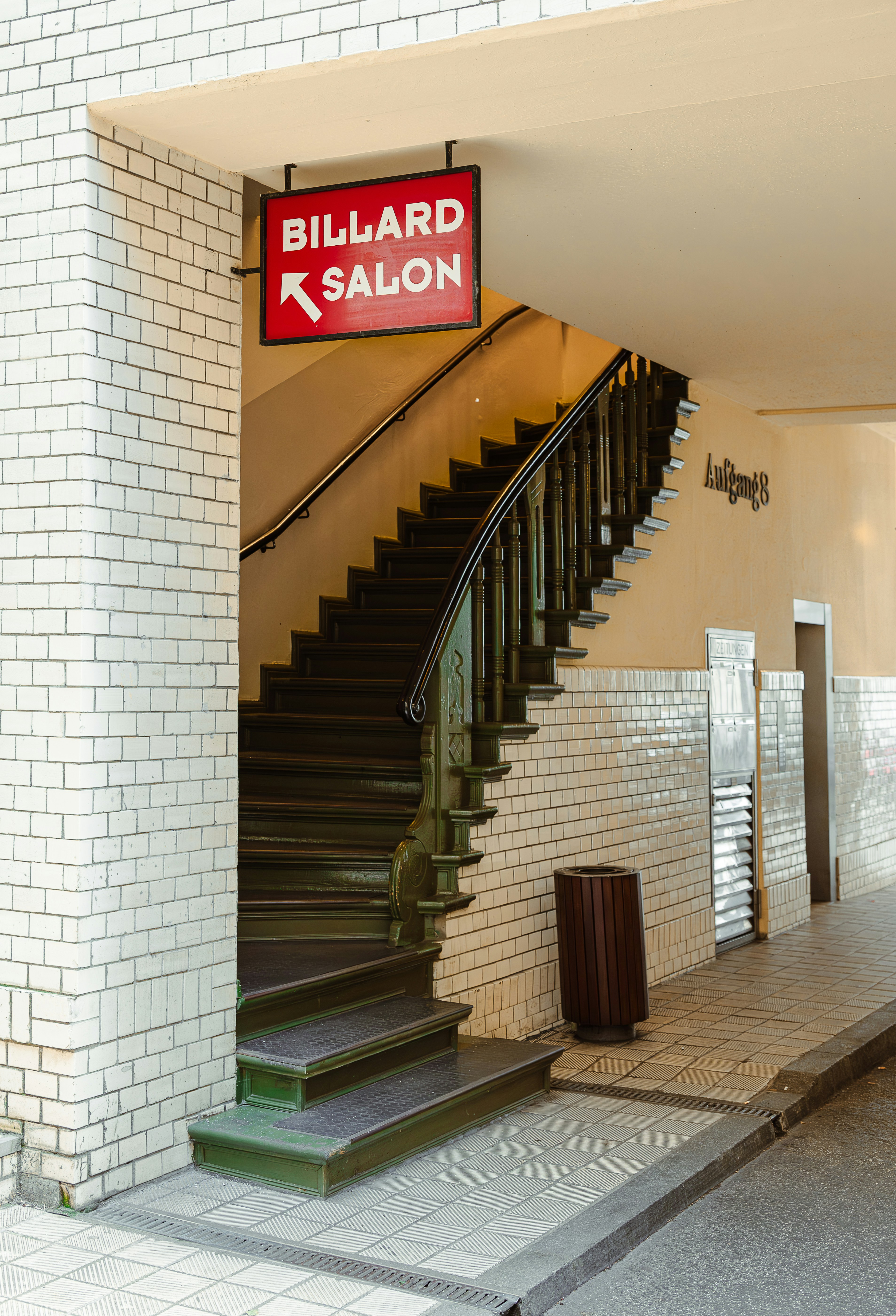 Staircase to a Red Sign: A Quiet Corridor of Transit