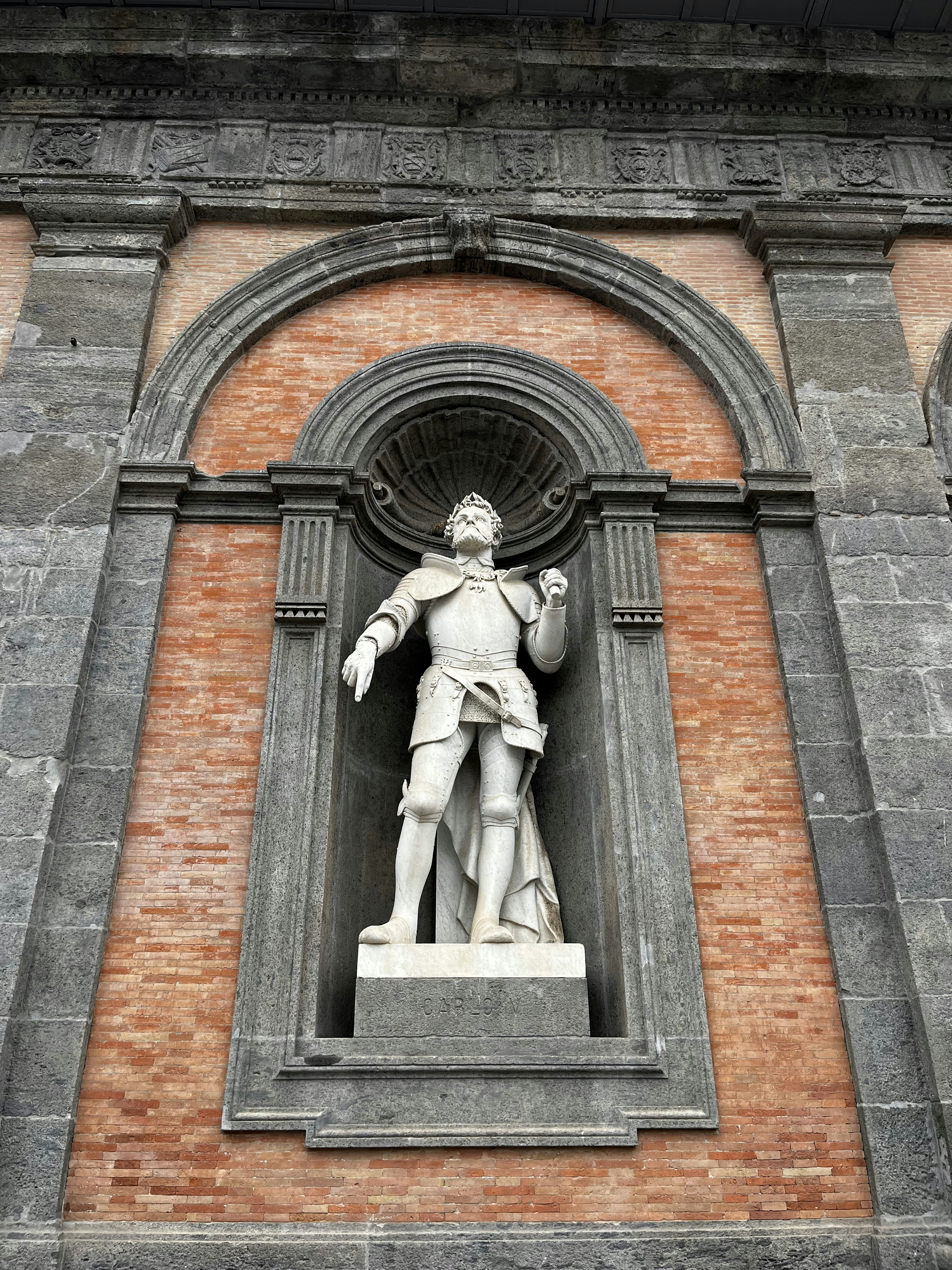 Brick Arch Sentinel: Marble Statue in a Stone Niche