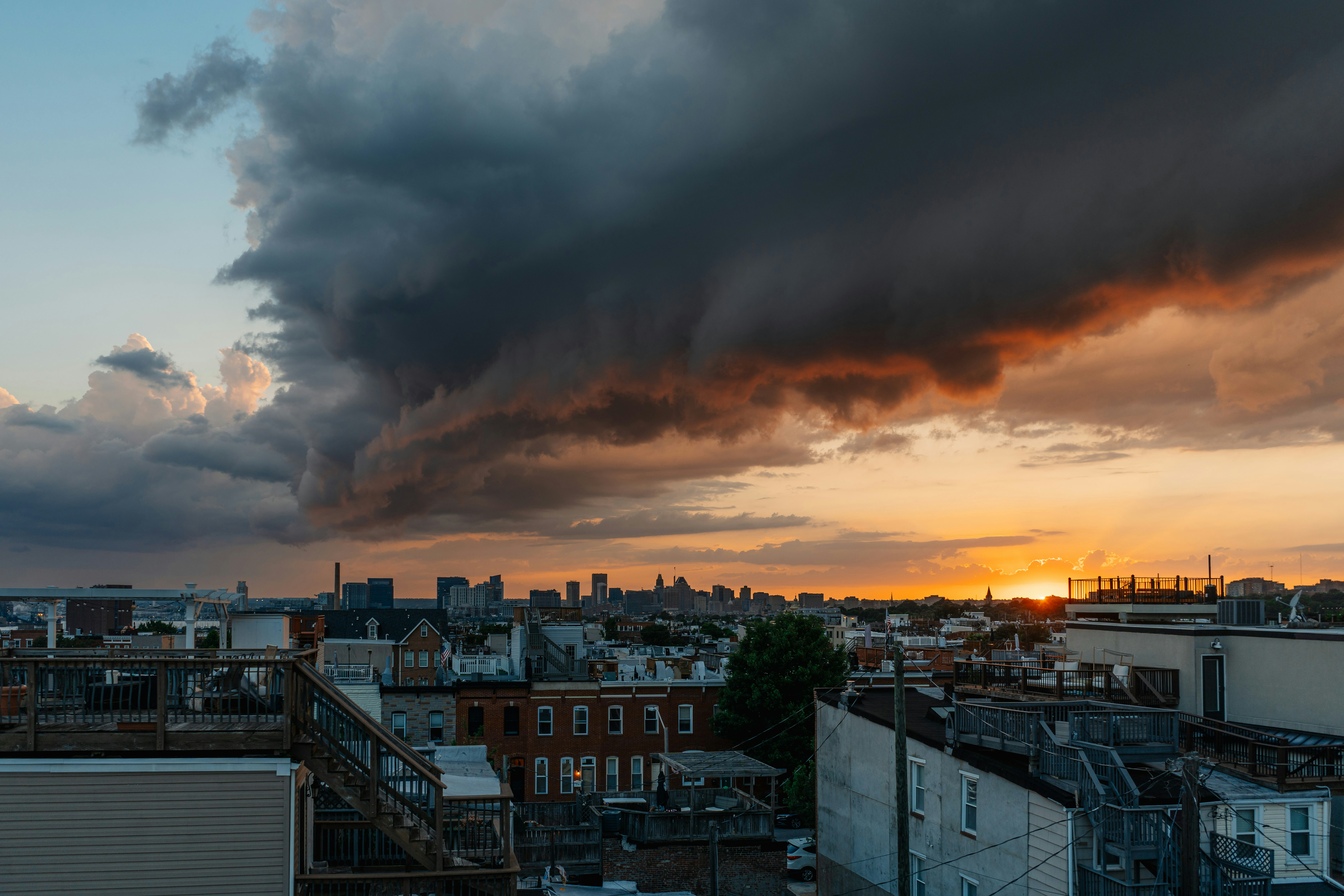 A view of a city from a rooftop at sunset photo – Free Baltimore Image ...