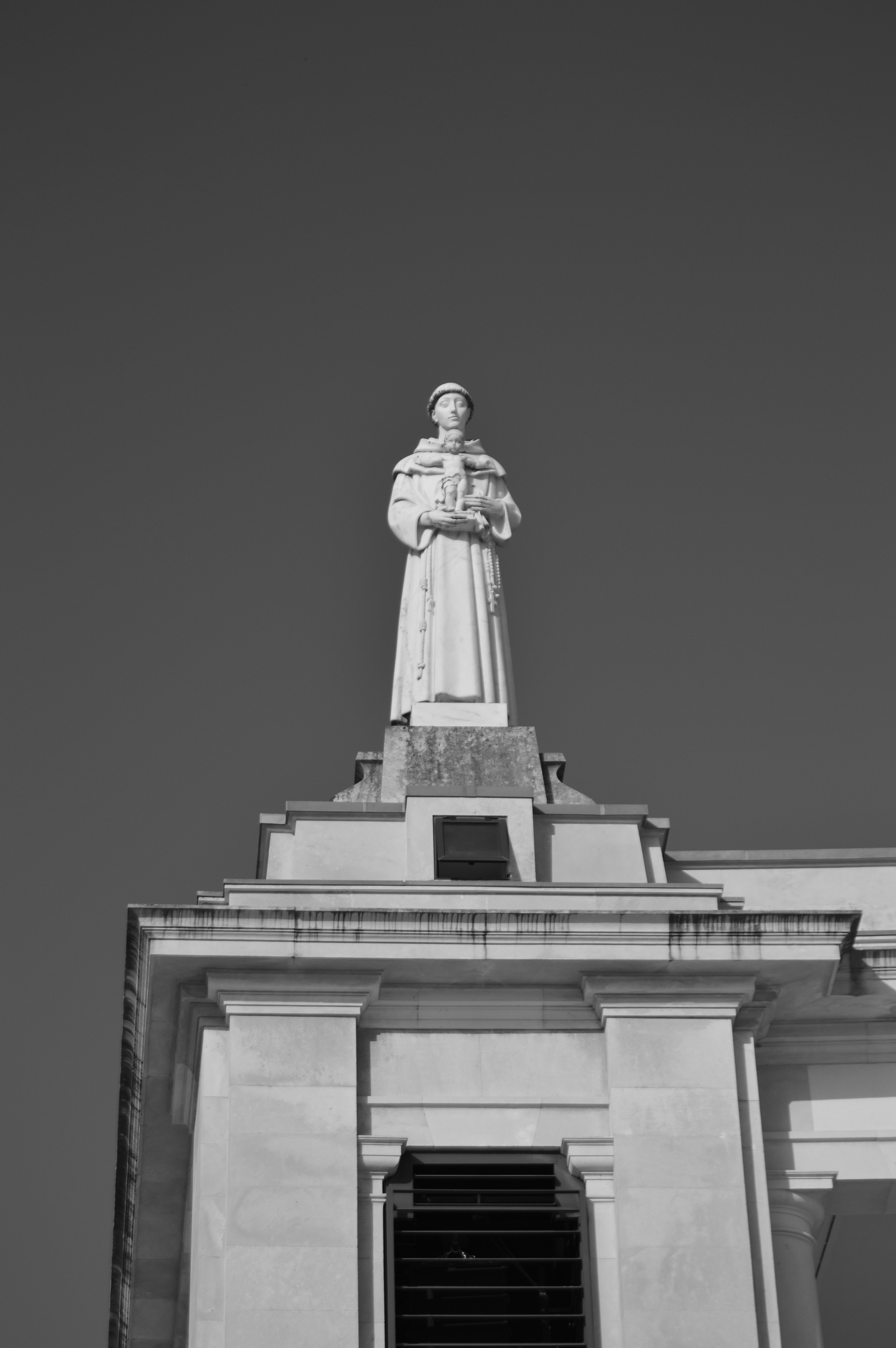 A black and white photo of a statue on top of a building photo – Free ...