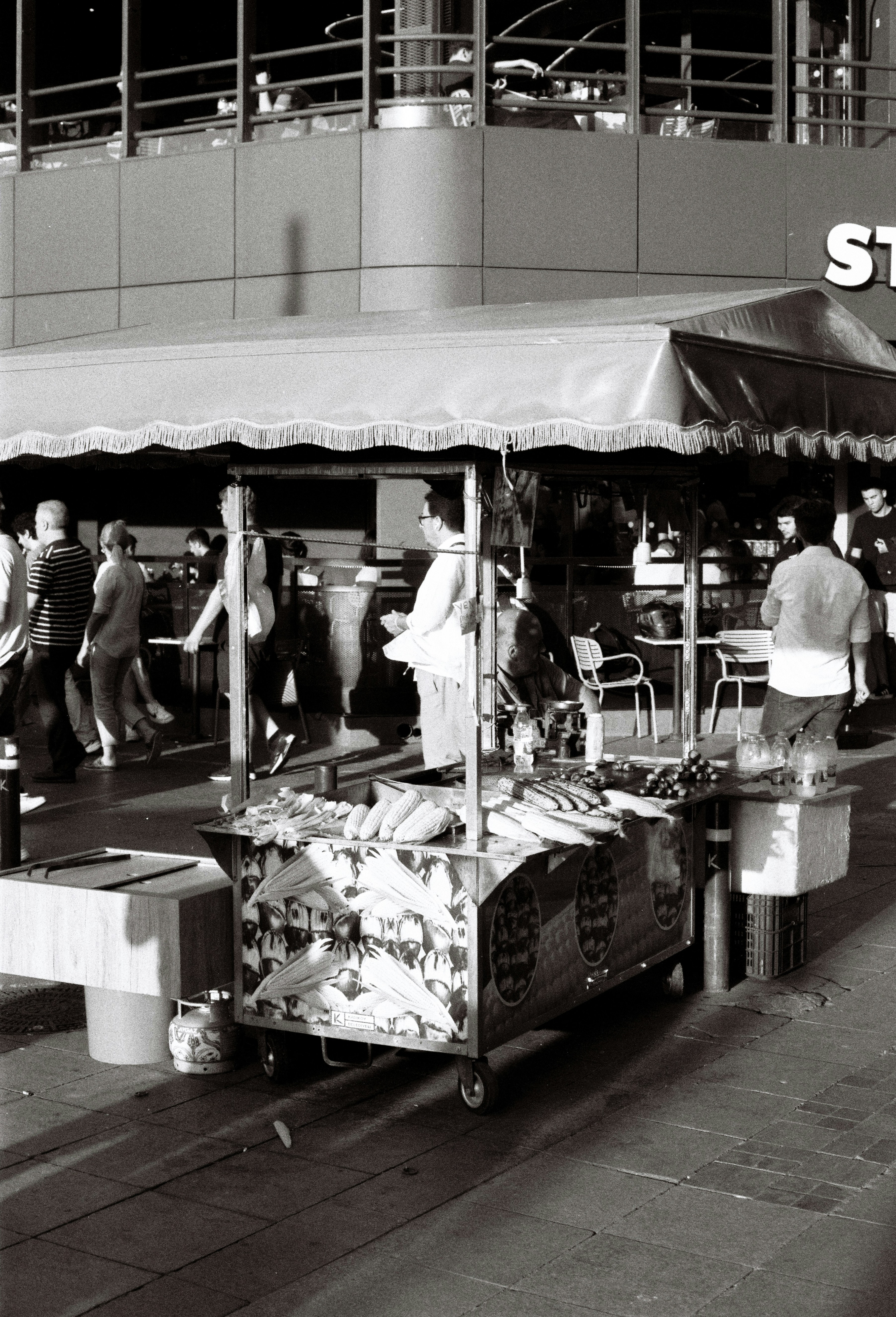 Cart Under the Canopy: A Quiet Moment on a Busy Street
