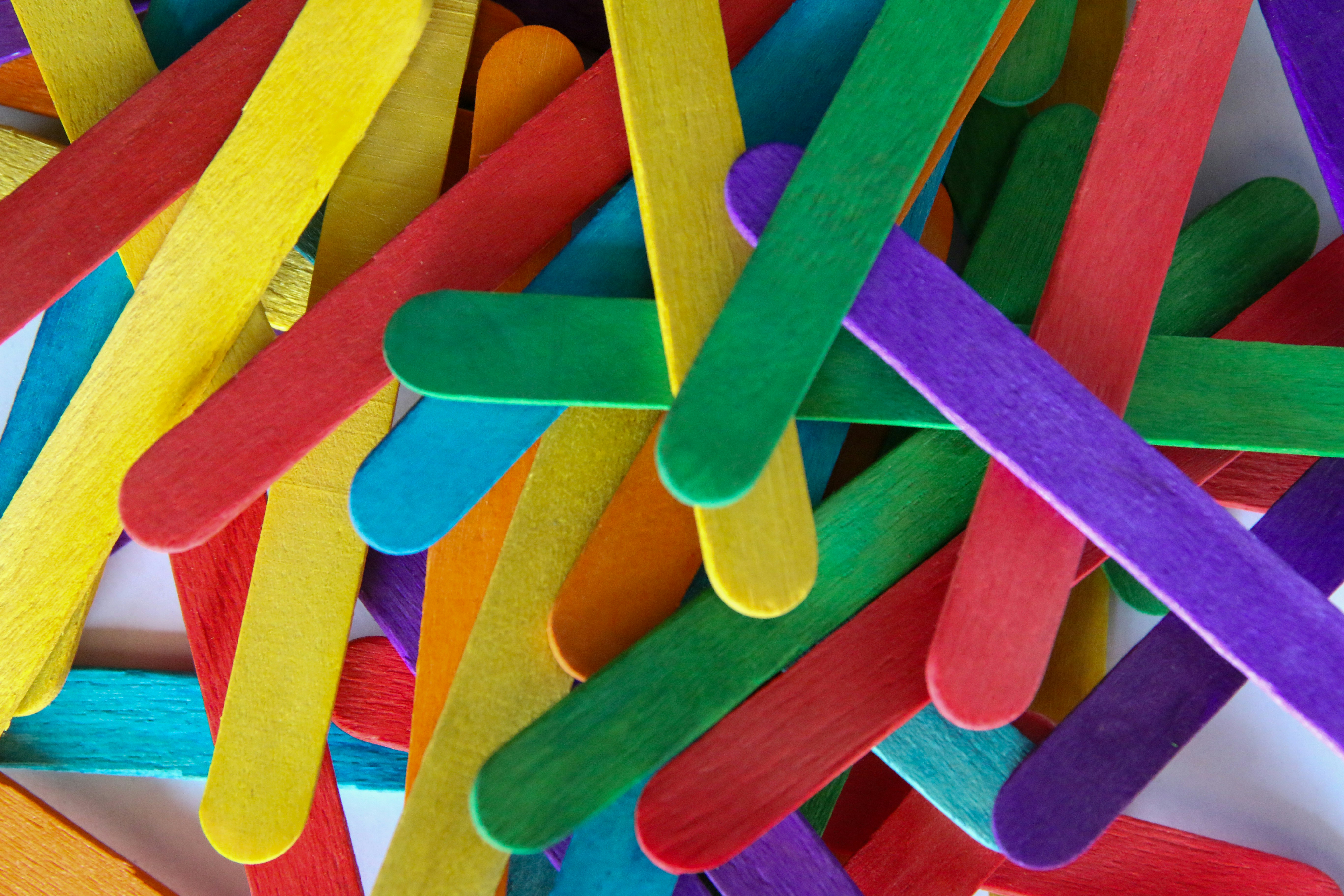 coloured sticks | A pile of colorful pops sticks sitting on top of each other