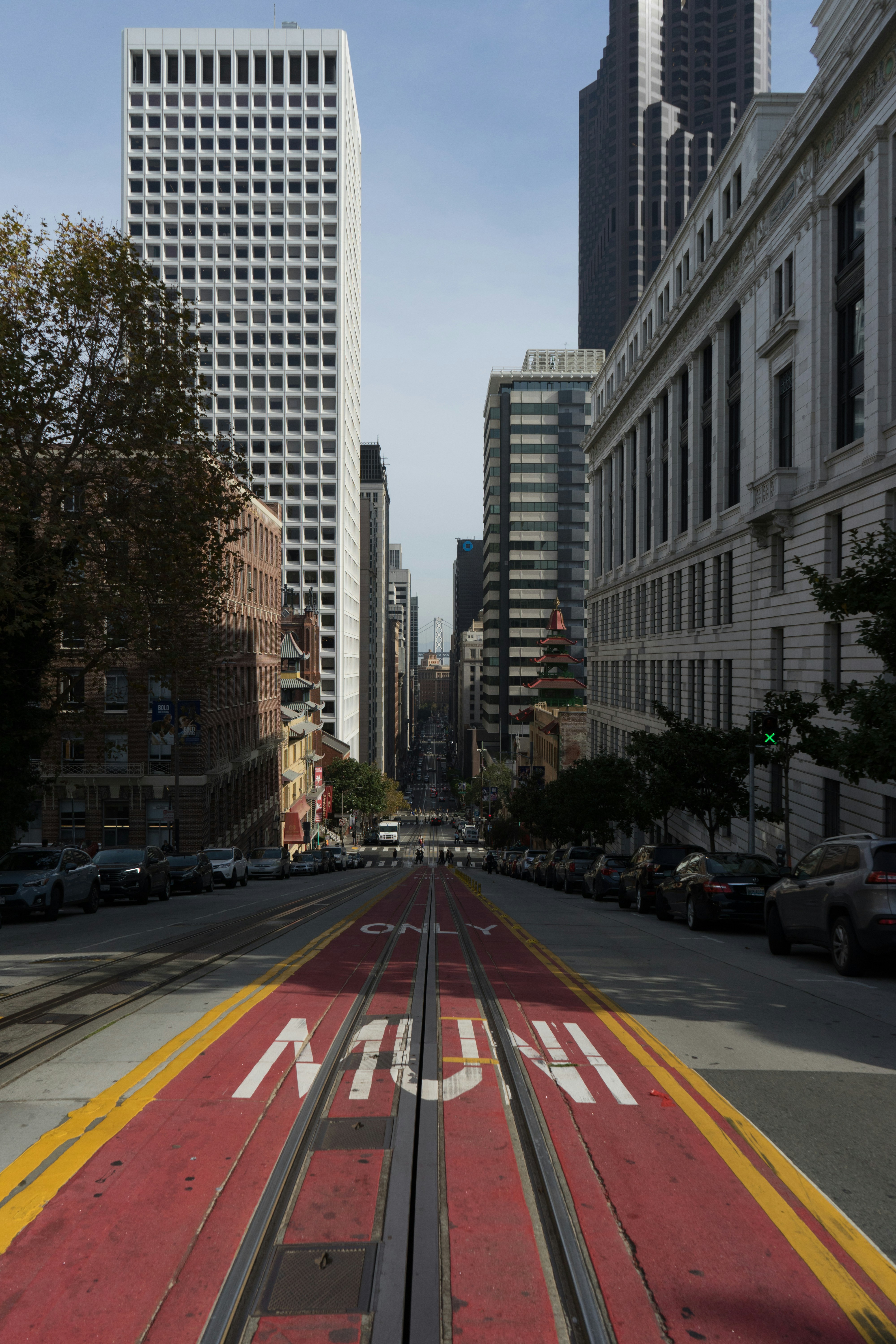 A city street with a train track in the middle of it photo – Free Car ...