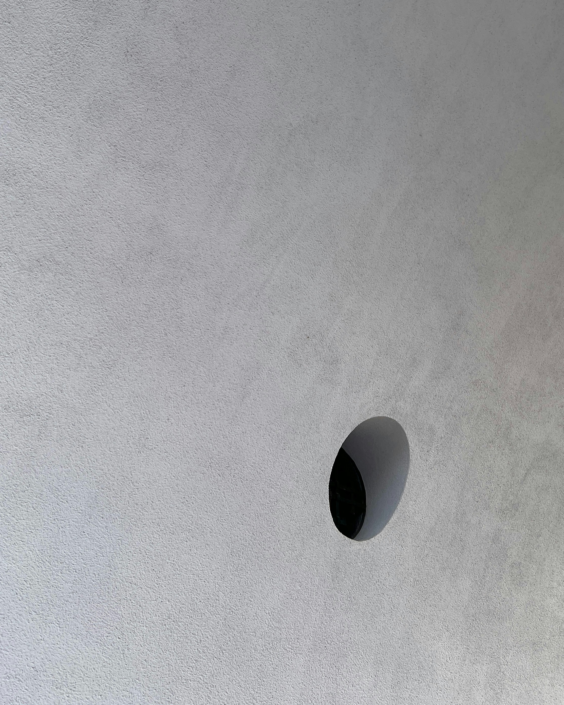 Oculus in the Plain: A Circular Aperture in Textured Plaster