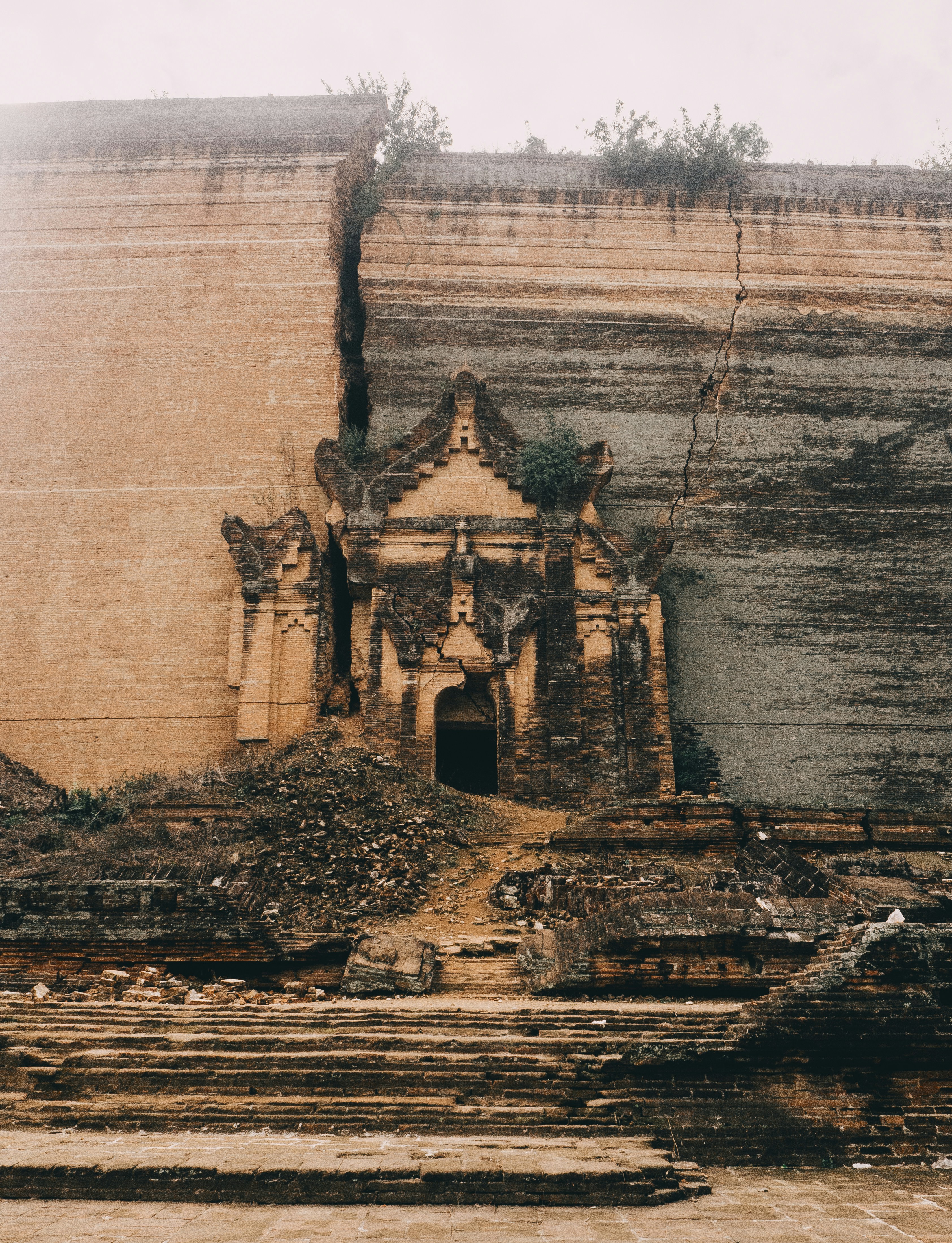 Cliffside Portal: Weathered Stone Temple Carved into the Cliff Face
