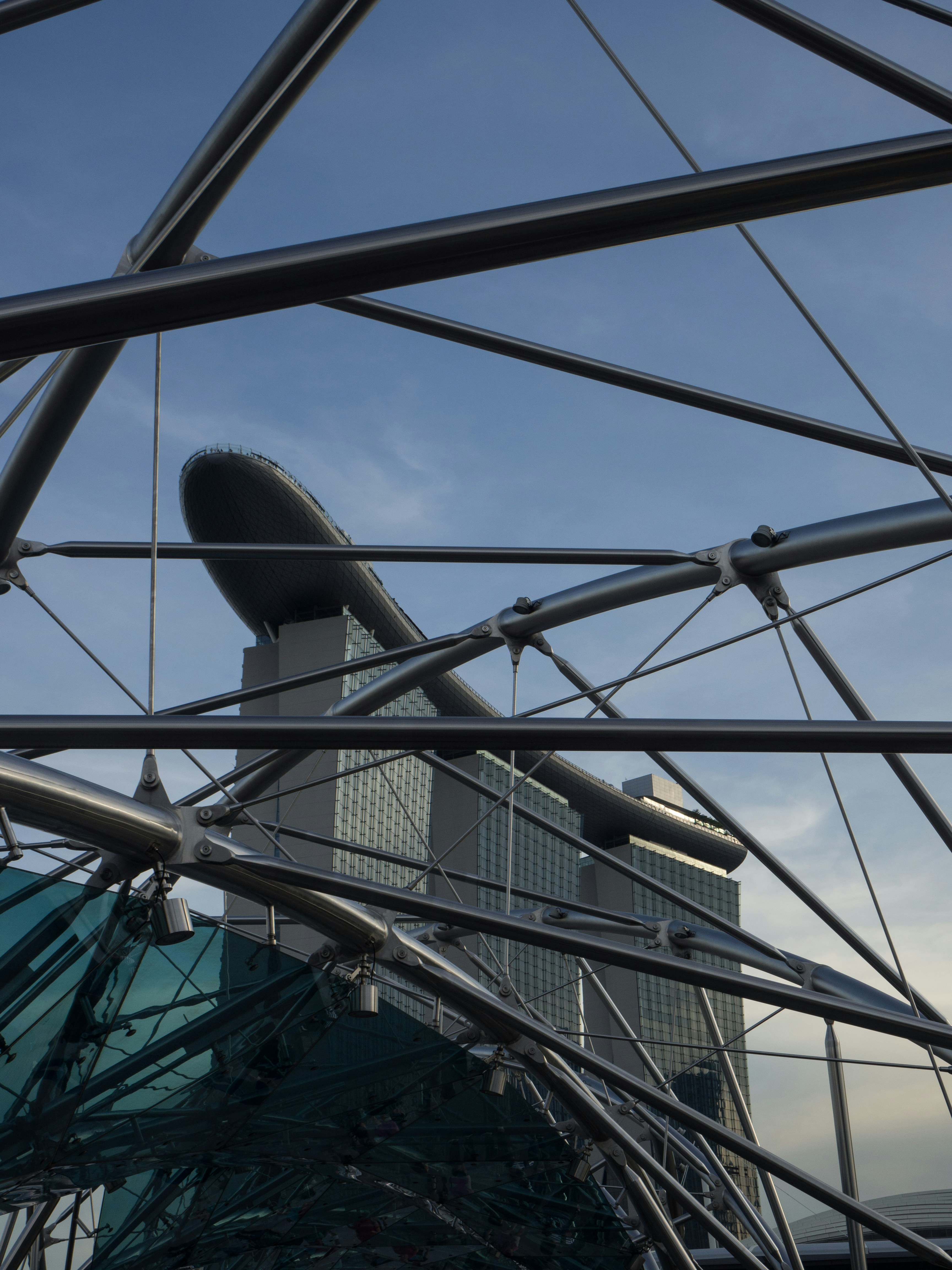 Webbed Skyline: Intersecting Steel Fragments Framing a Towering City