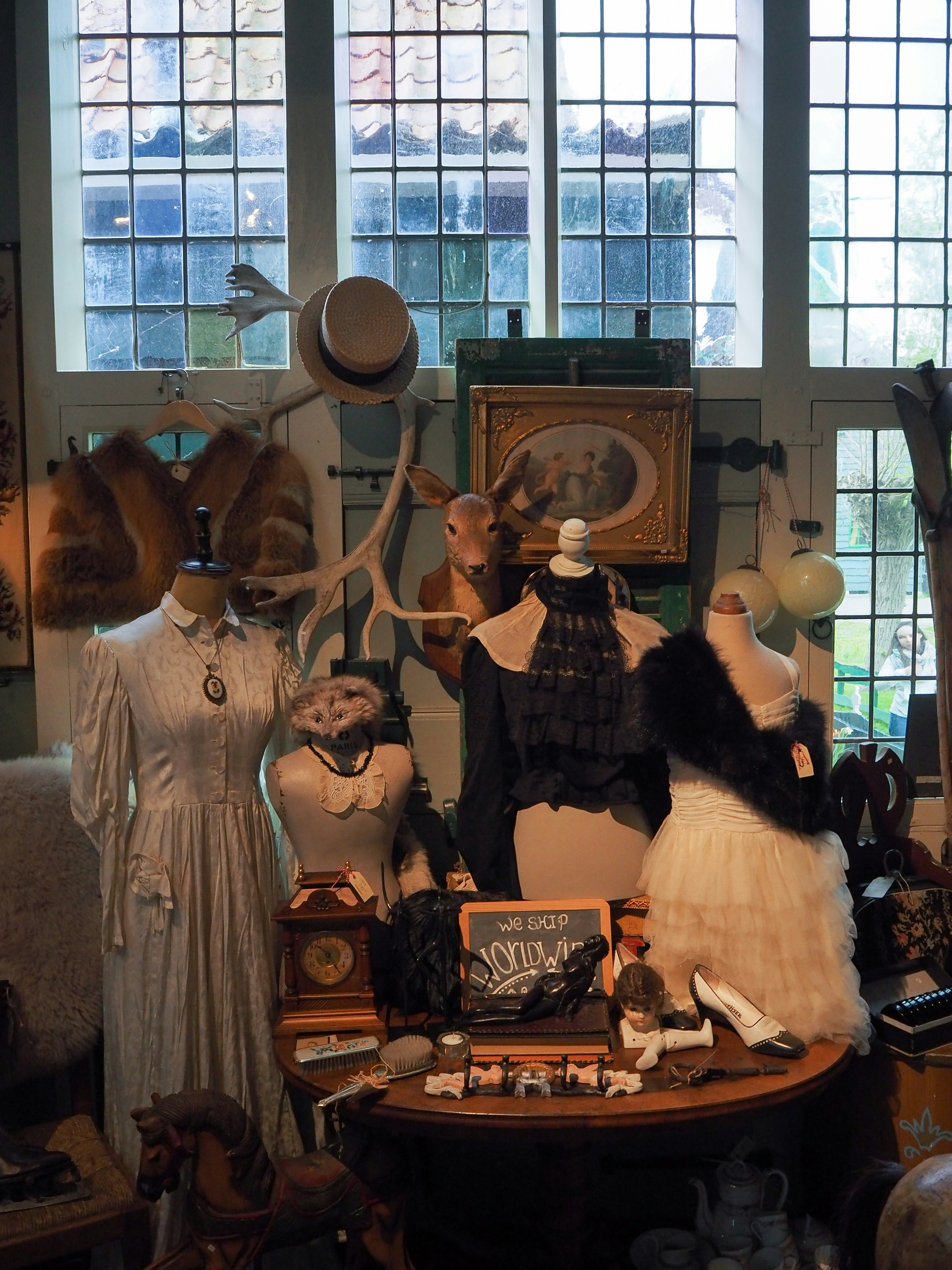 Vintage Boutique Still Life: Dresses, Hats, and Curios in Soft Window Light