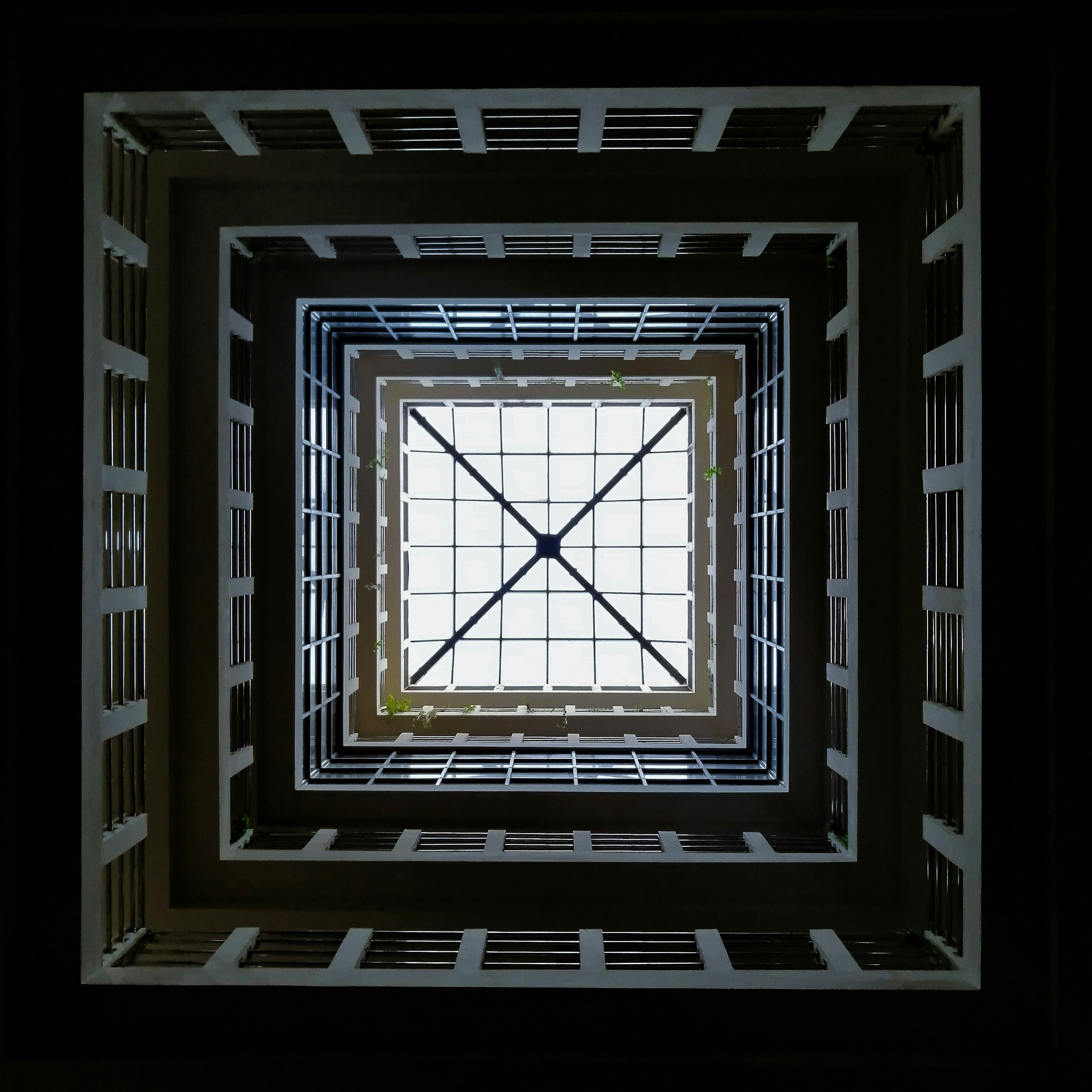 A view of a square window in a building photo – Free East west ...