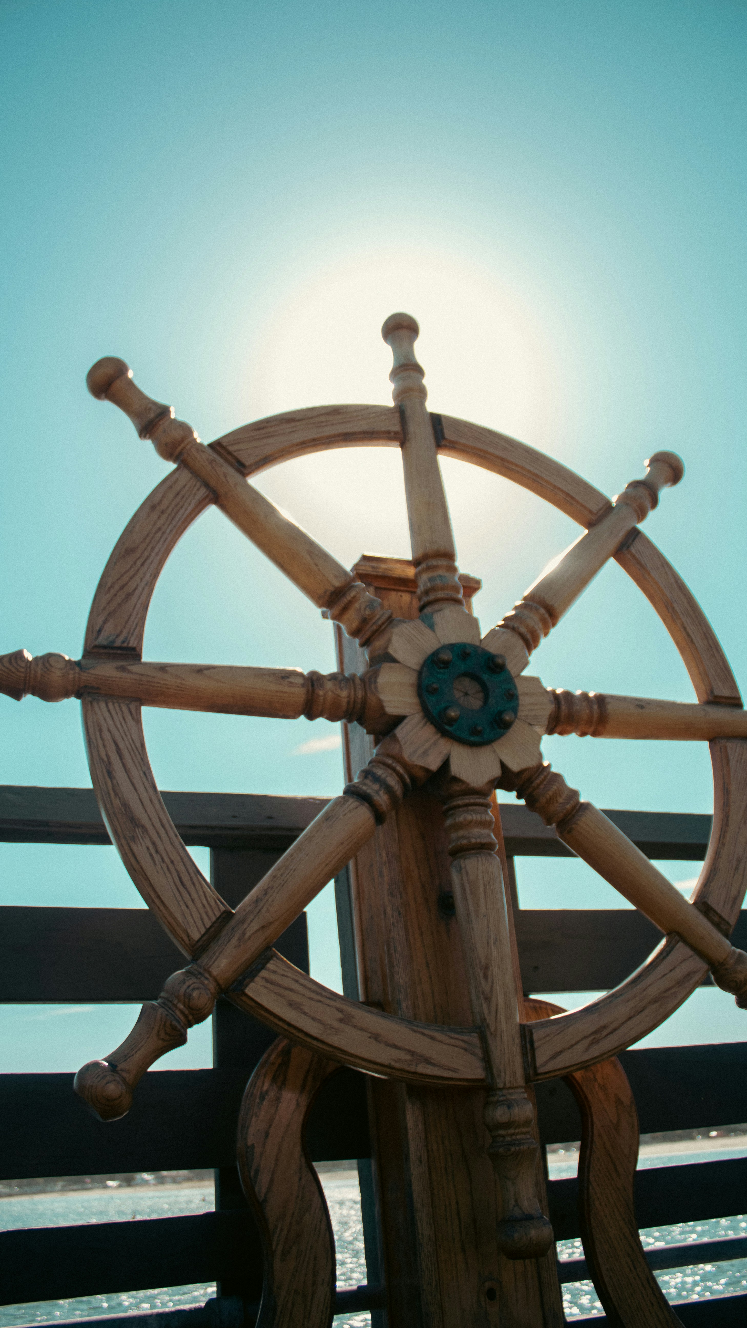 Sunlit Helm: Weathered Wheel Framed by a Turquoise Sky