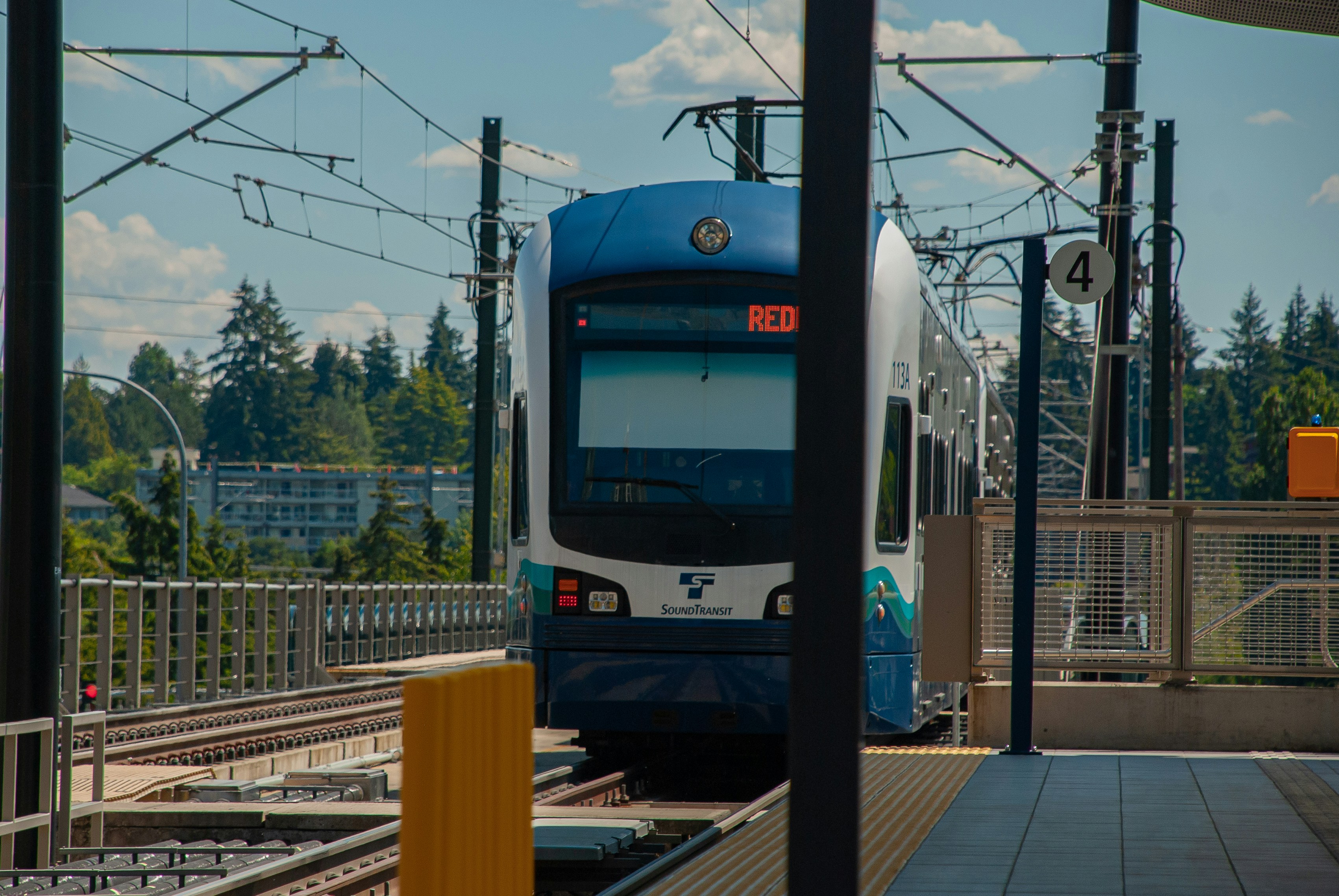 A blue and white train traveling down train tracks photo – Free Human ...