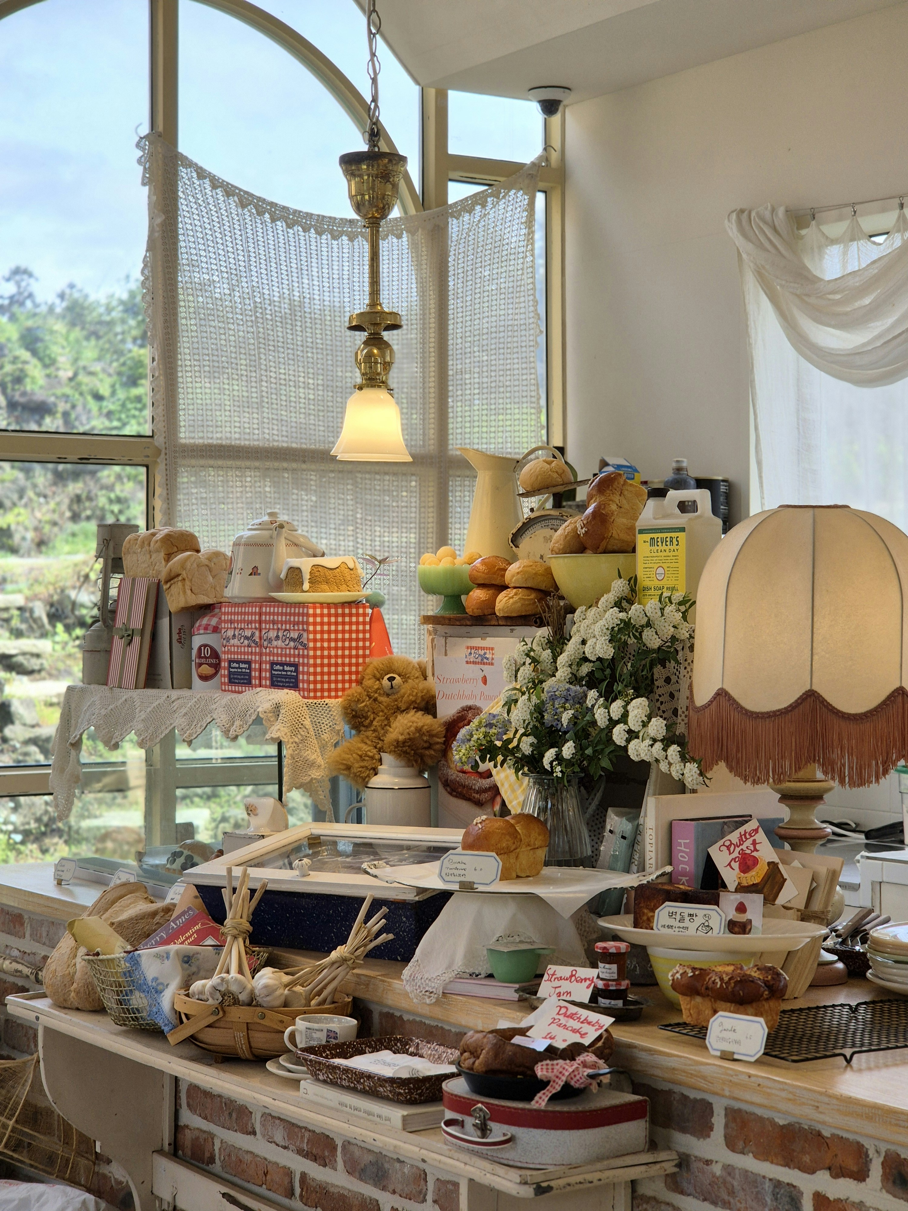 Sunlit Display of Pastries and Treasures in a Cozy Brunch Nook