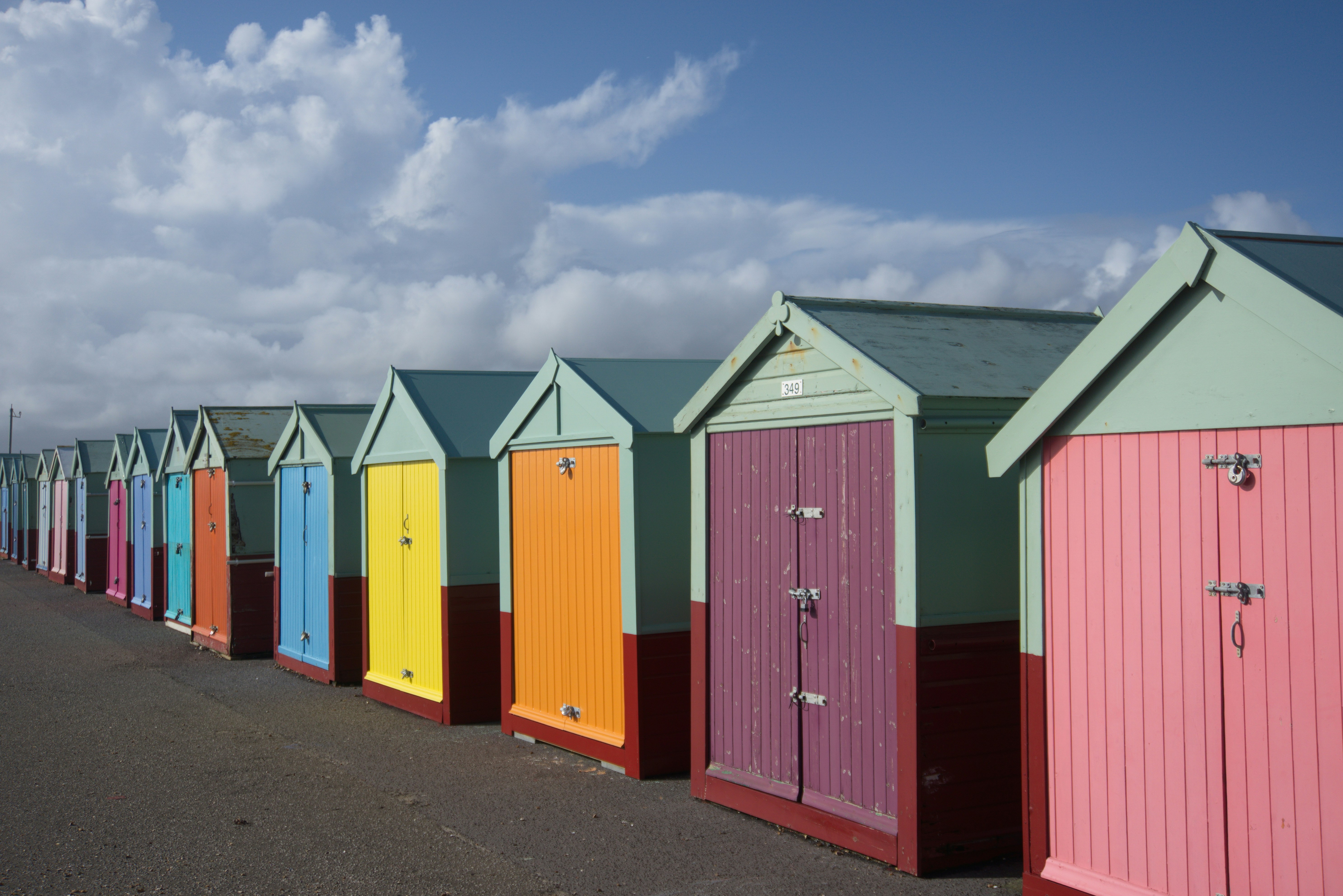 A row of colorful beach huts sitting next to each other photo – Free ...