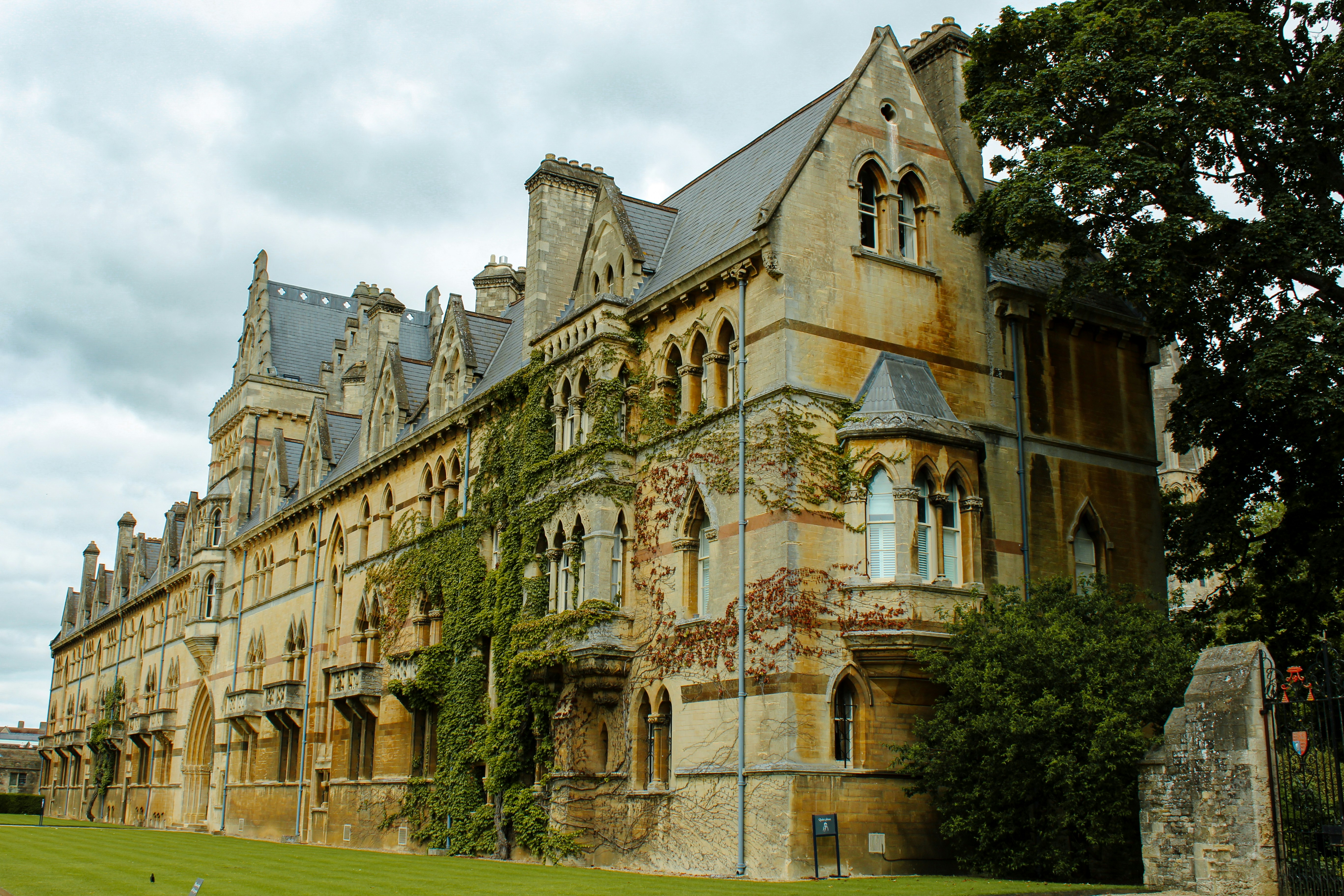 A large stone building with a clock on the front of it photo – Free ...