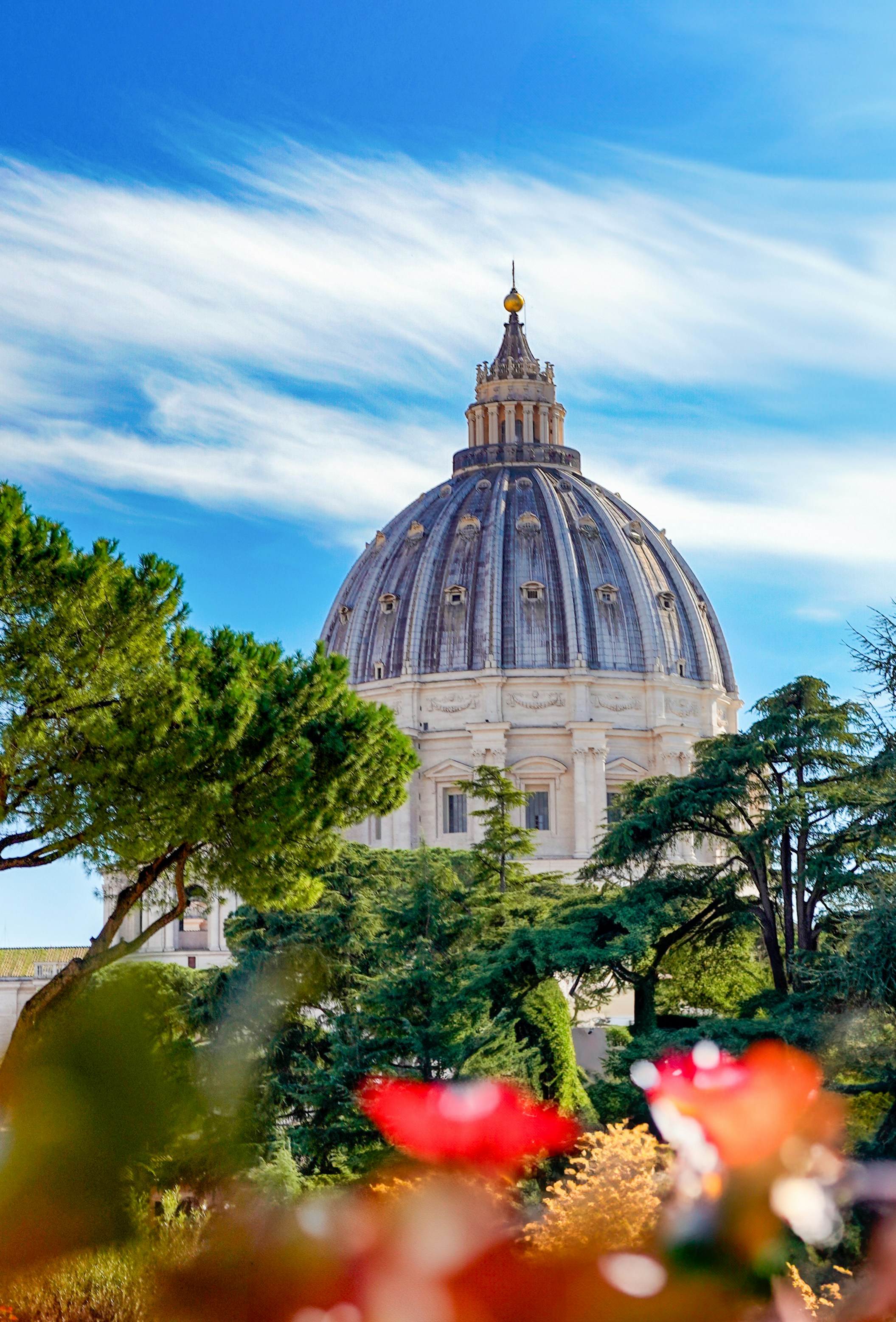 Dome in Focus: Saint Peter’s Rising Above Verdant Foreground Under a Cerulean Sky
